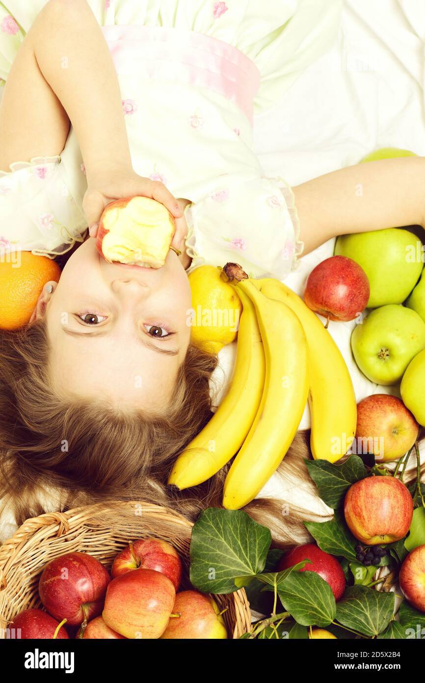 small happy girl eating exotic fruit or summer background Stock Photo ...