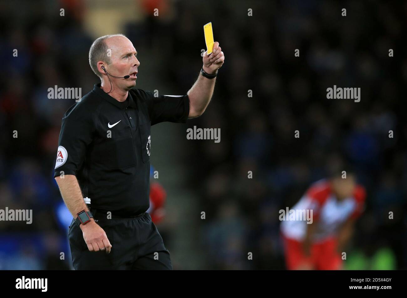 Match referee Mike Dean gives a yellow card Stock Photo - Alamy