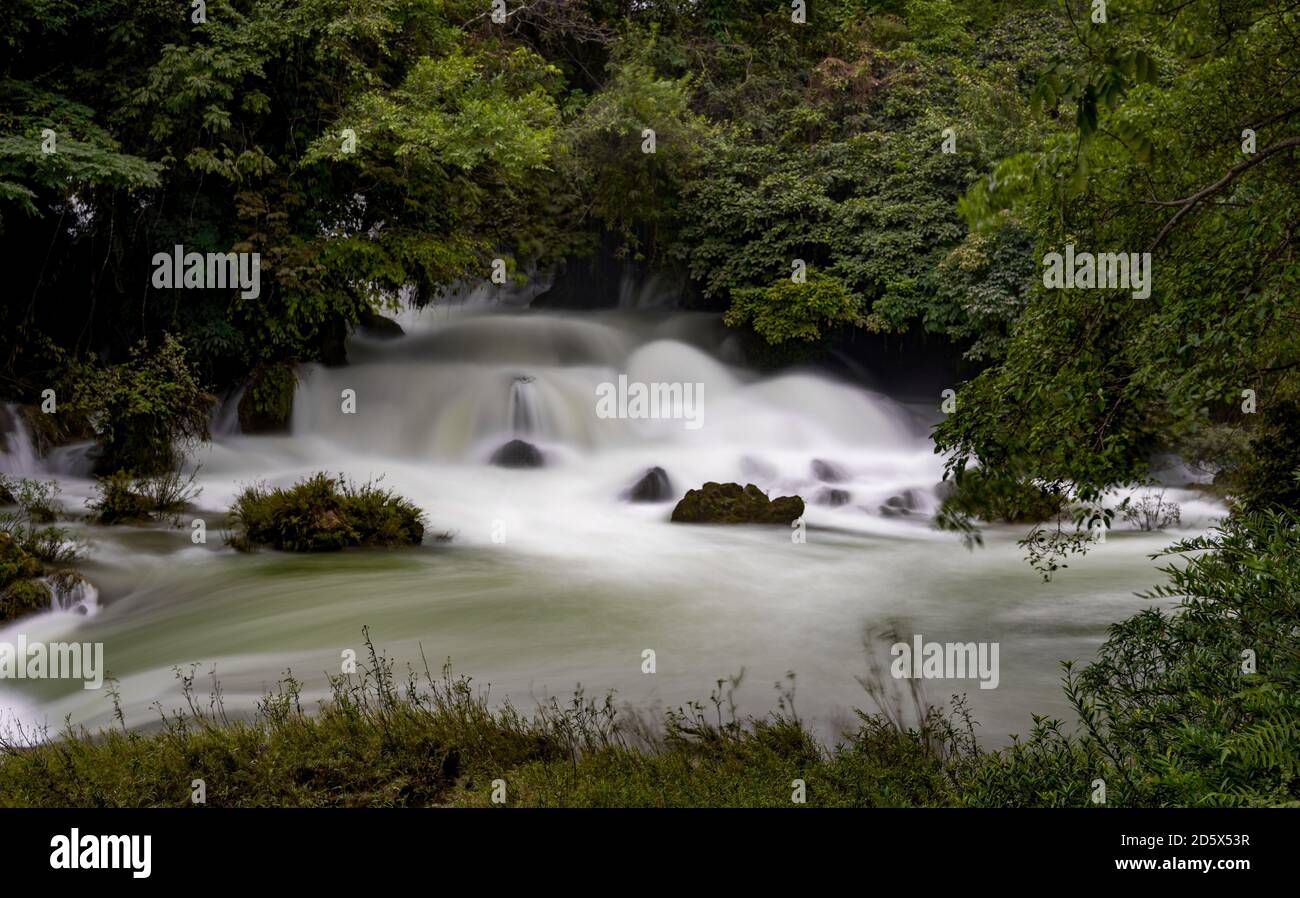 Small waterfall, stream, water flow in the jungle Stock Photo - Alamy