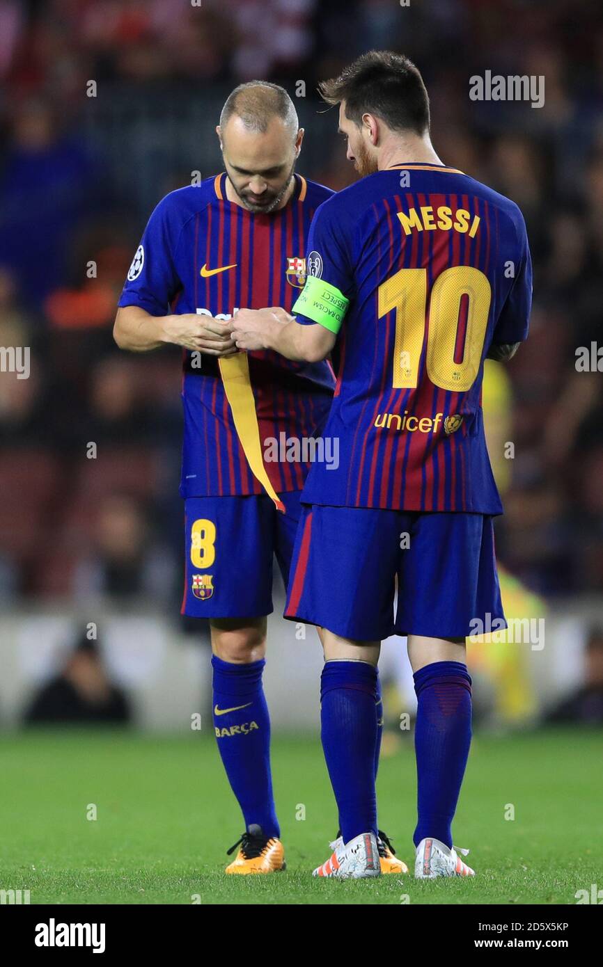 Barcelona's Andres Iniesta (left) hands team mate Lionel Messi the ...