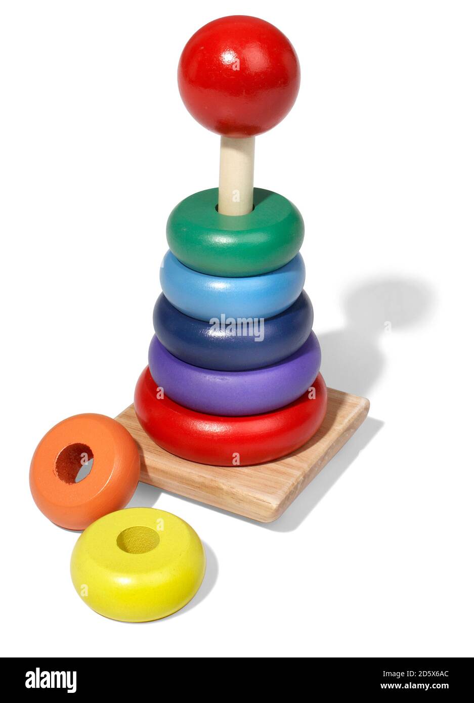 multi-colored wooden ring puzzle for kids photographed on a white ...