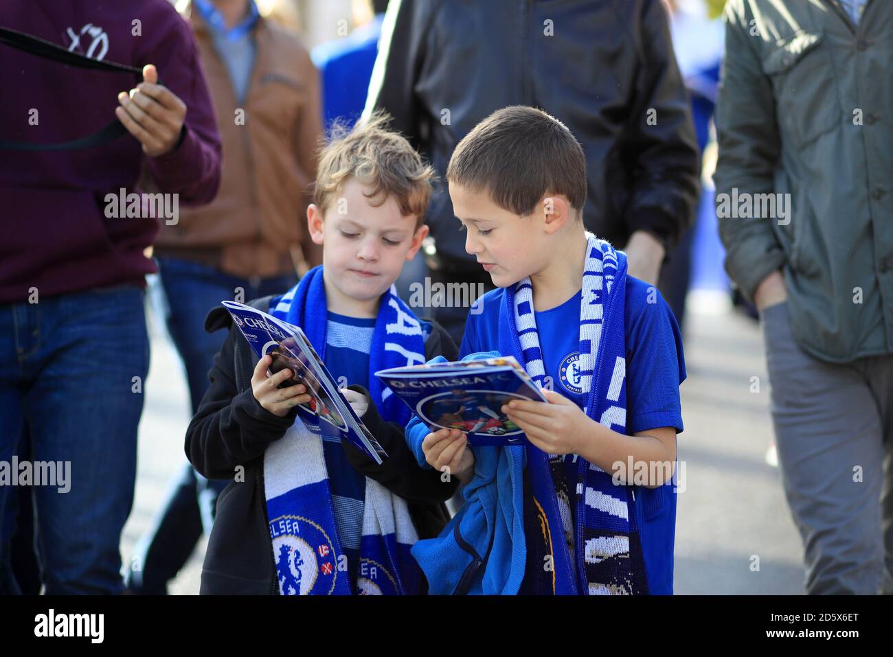 Young Chelsea fans read the match day programme Stock Photo - Alamy
