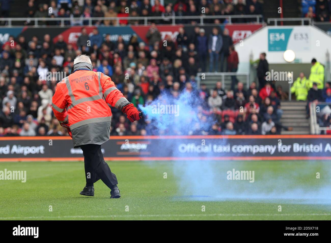 A steward removes a leeds flare from the pitch Stock Photo - Alamy