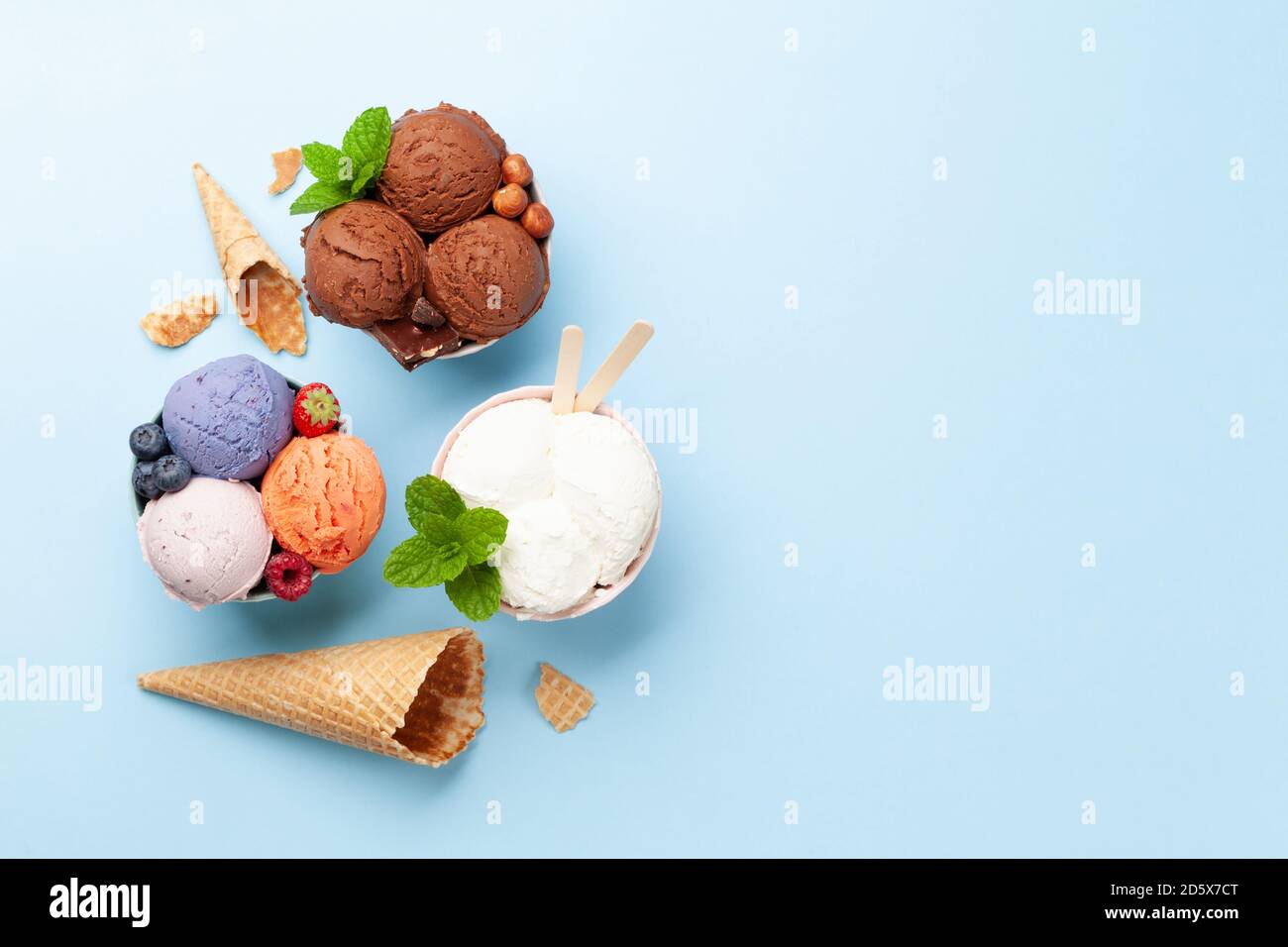 Berry, vanilla and chocolate ice cream sundae. Top view flat lay with ...