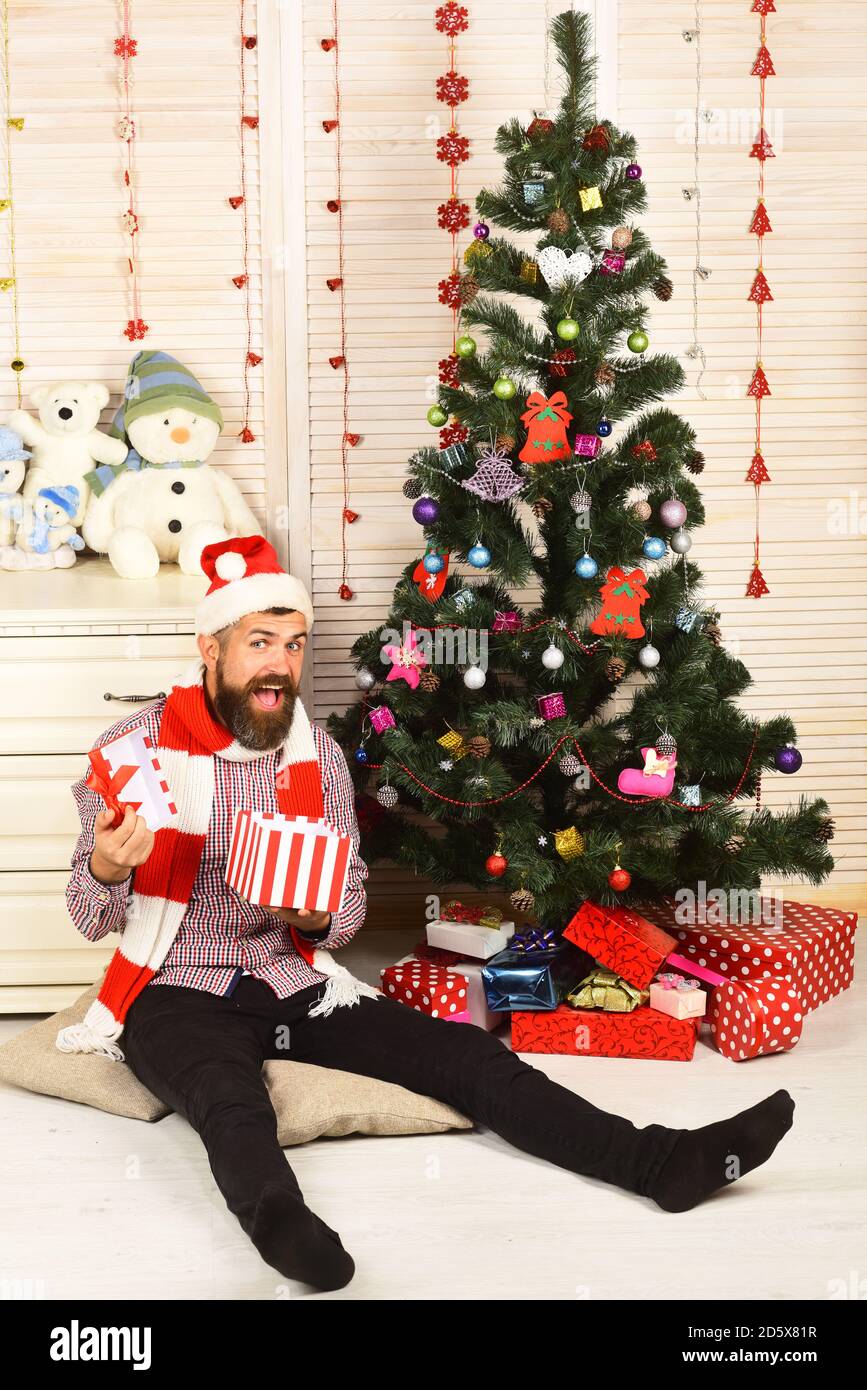 Santa Claus with excited face on bureau with toy snowman and Christmas ...