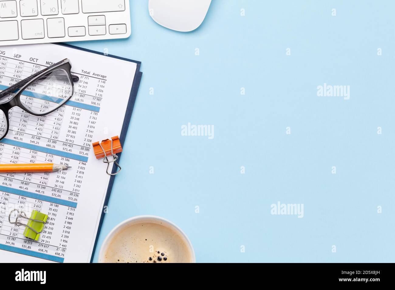 Business desk workplace and office objects over blue backdrop. Top view ...