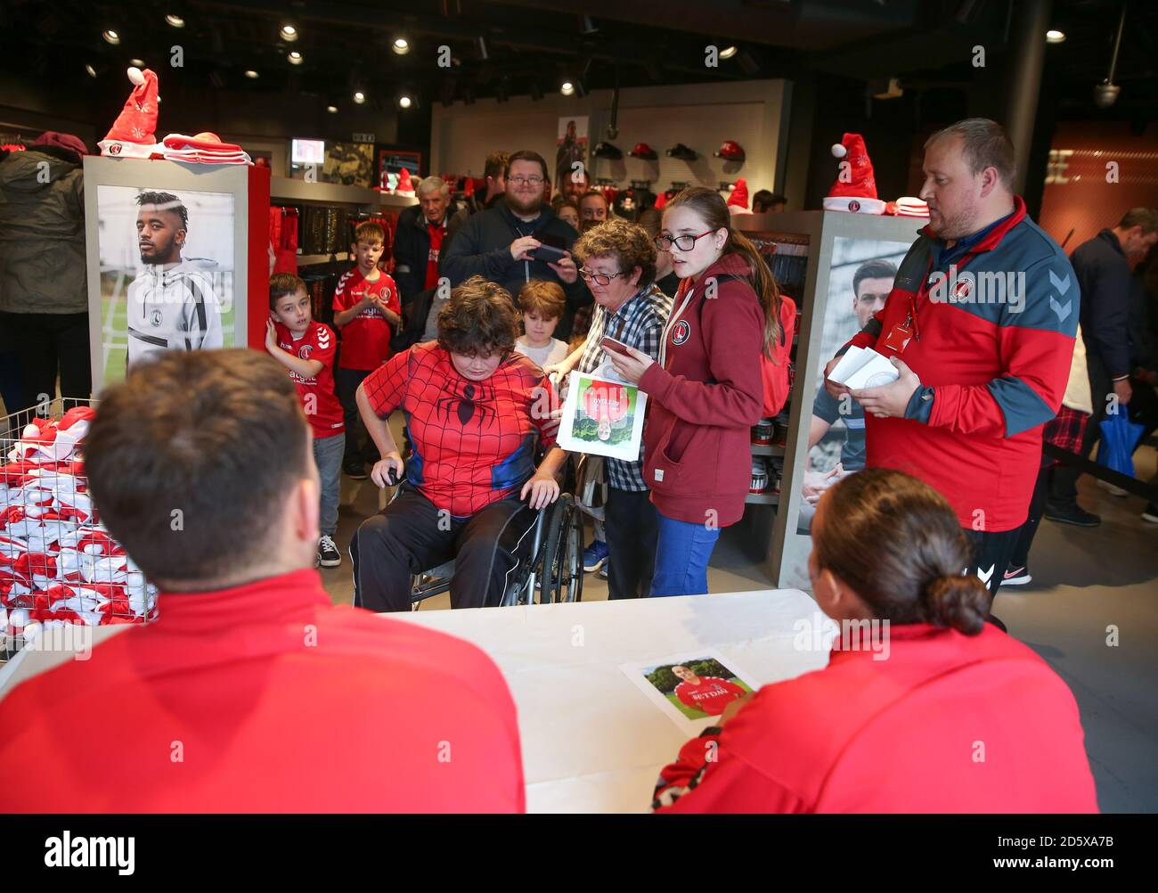 Charlton Athletic's Jason Pearce (left) and Kim Dixson sign autographs ...