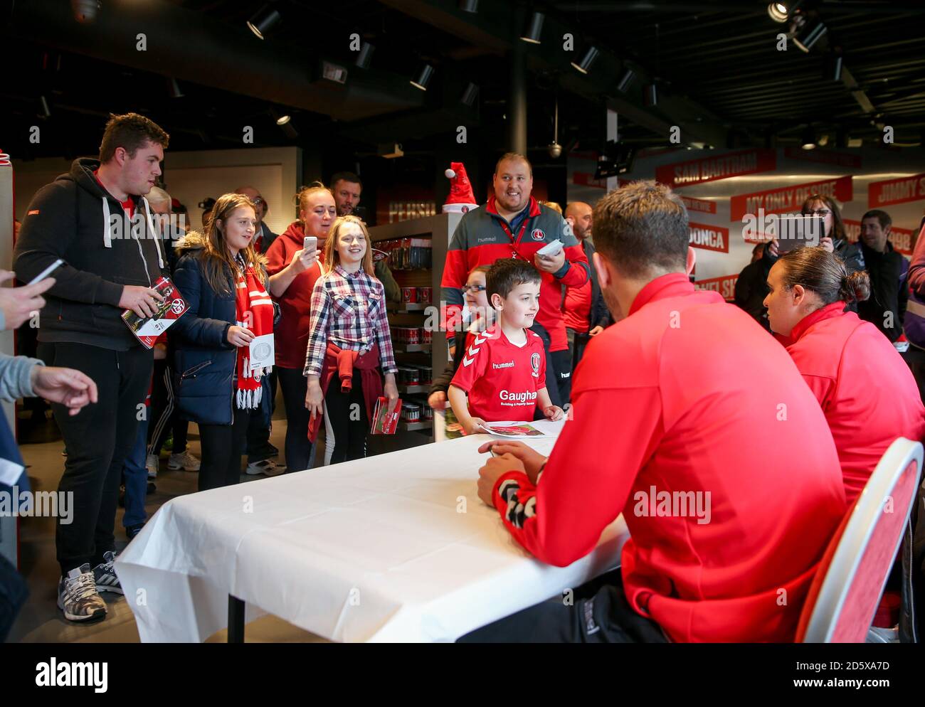 Charlton Athletic's Jason Pearce (left) and Kim Dixson sign autographs ...