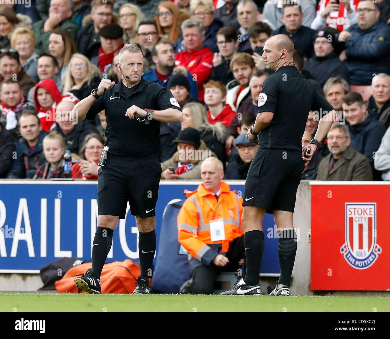 Match referee Bobby Madley (right) leaves the game and colleague Jon ...