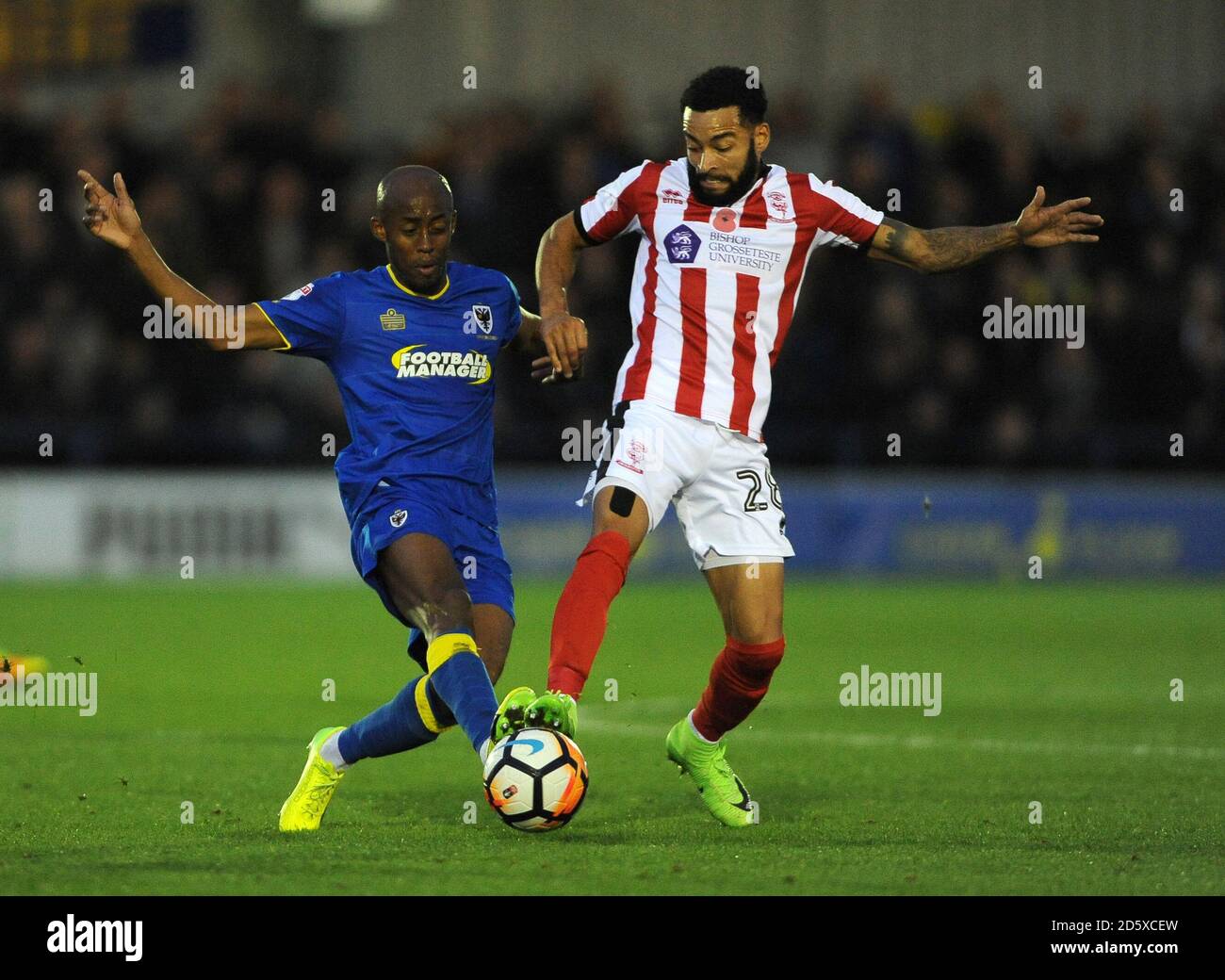 AFC Wimbledon's Jimmy Abdou and Lincoln City's Nathan Arnold battle for ...
