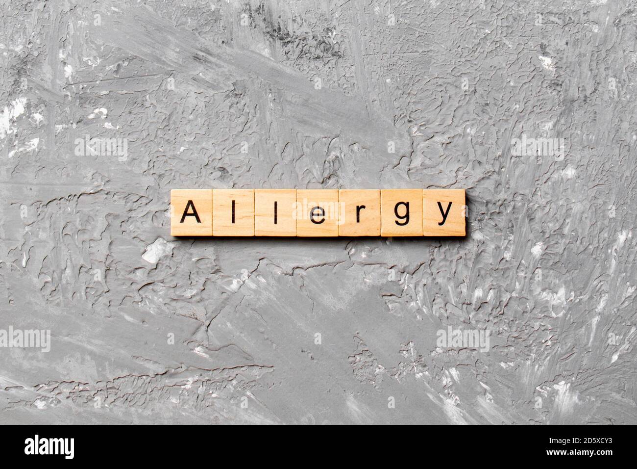 Allergy word written on wood block. Allergy text on cement table for ...