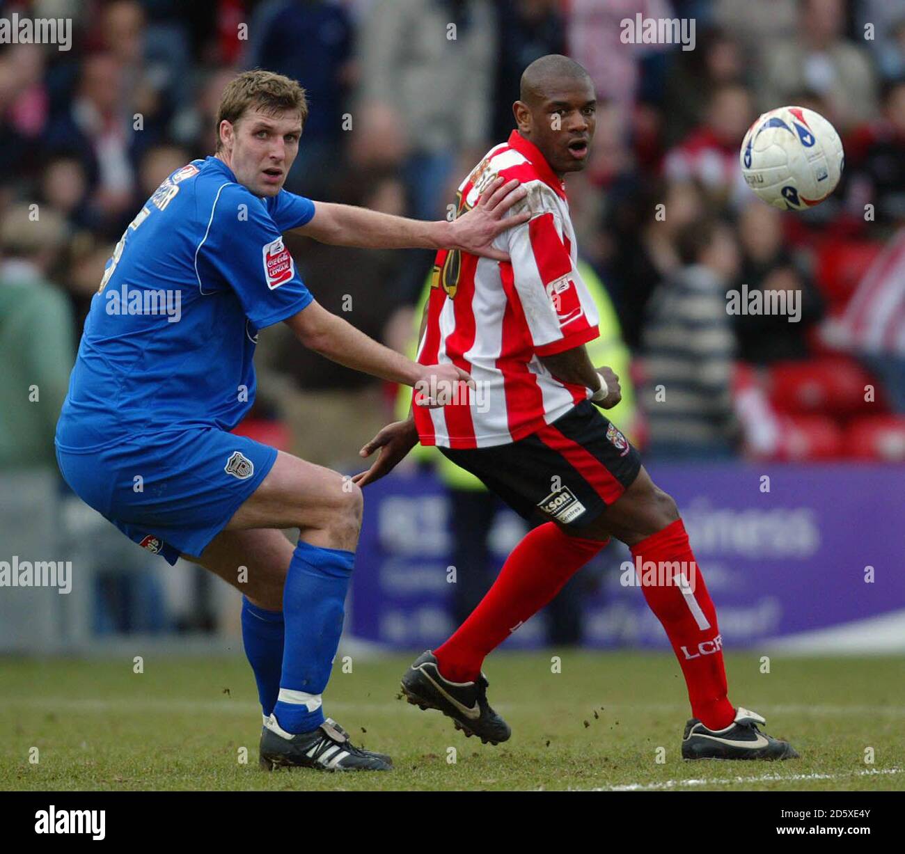 Lincoln City's Marvin Robinson and Grimsby Town's Ben Futcher battle ...