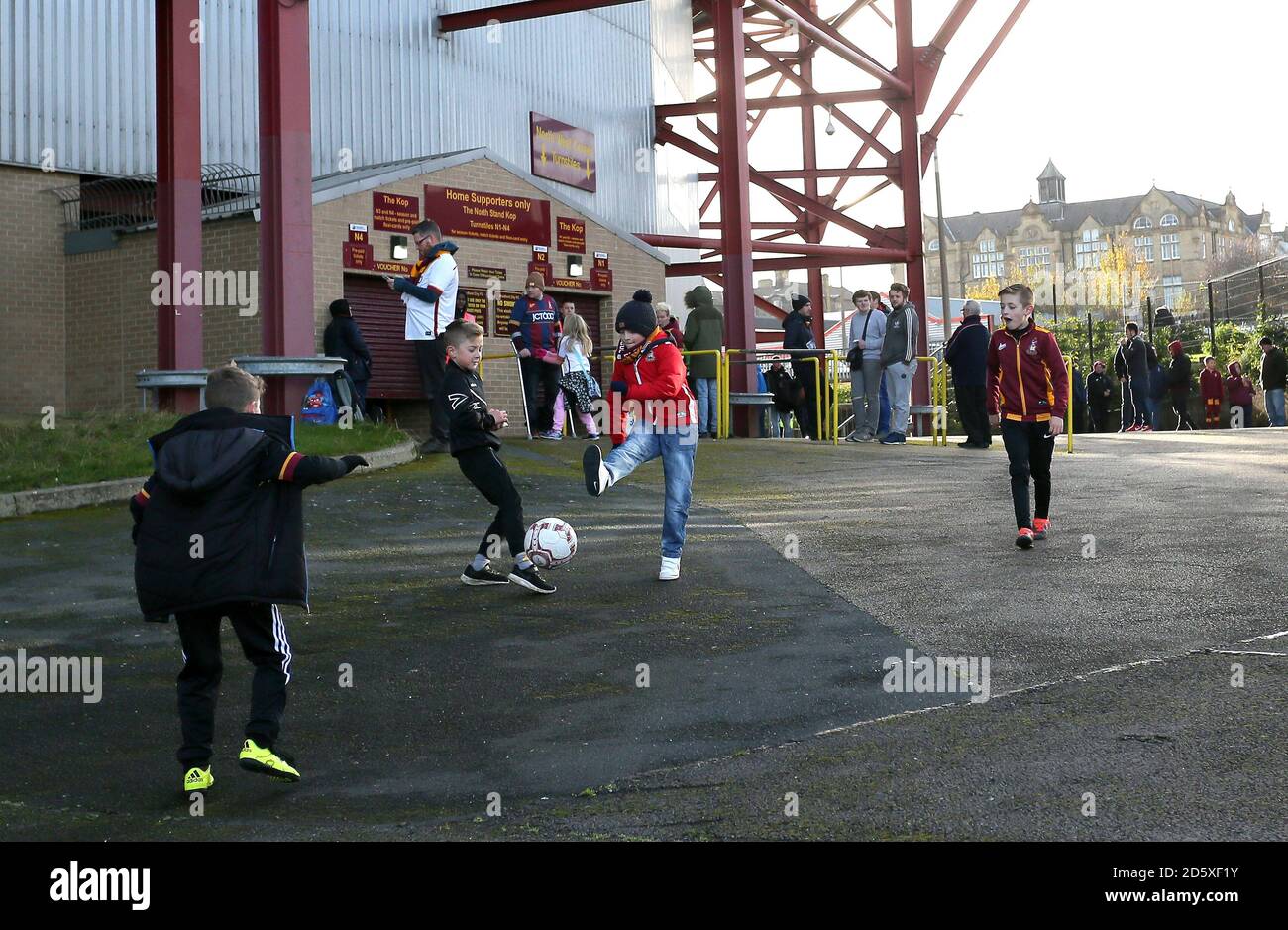 Children playing football outside the stadium prior to the match Stock ...