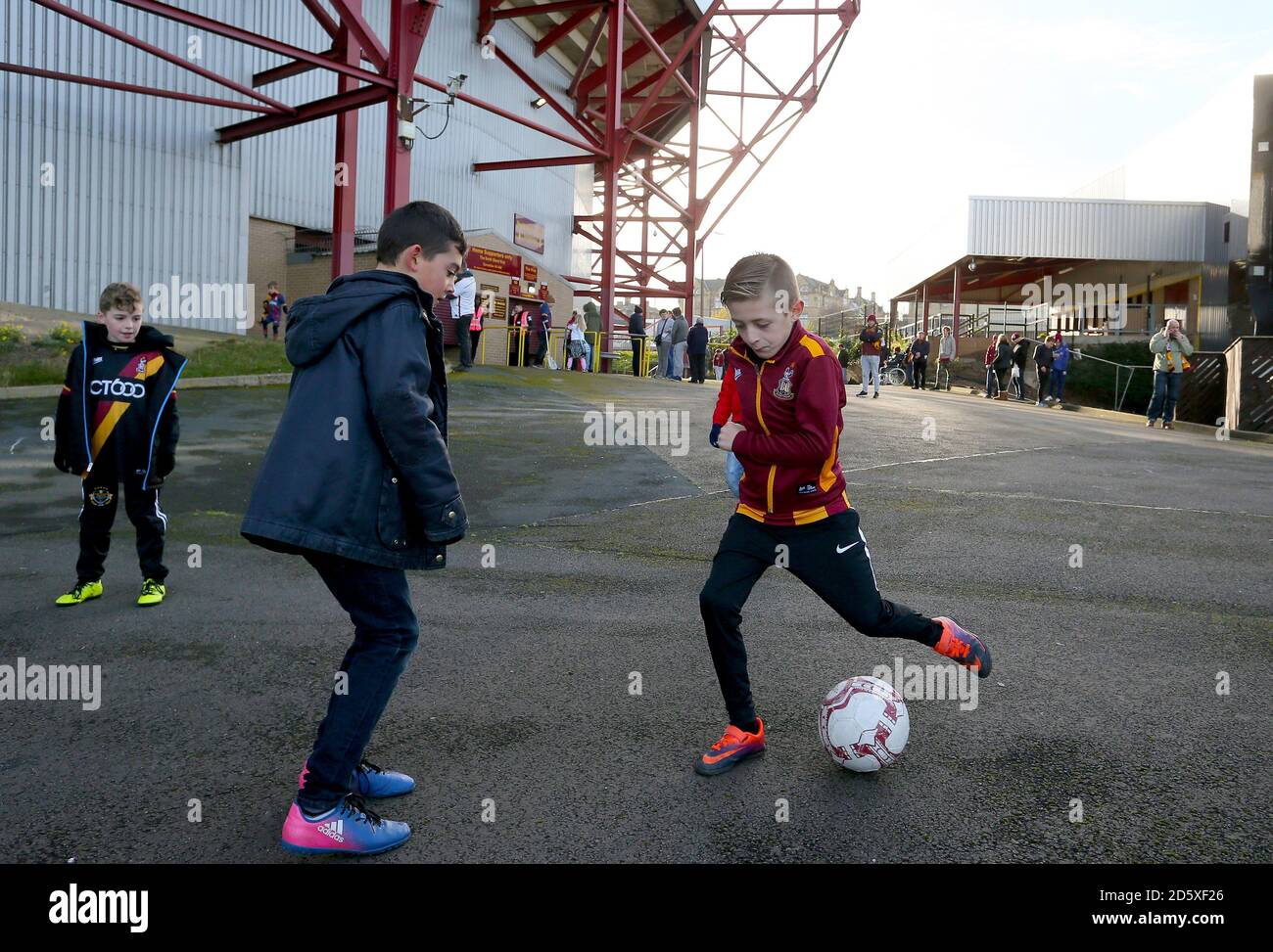 Children playing football outside the stadium prior to the match Stock ...