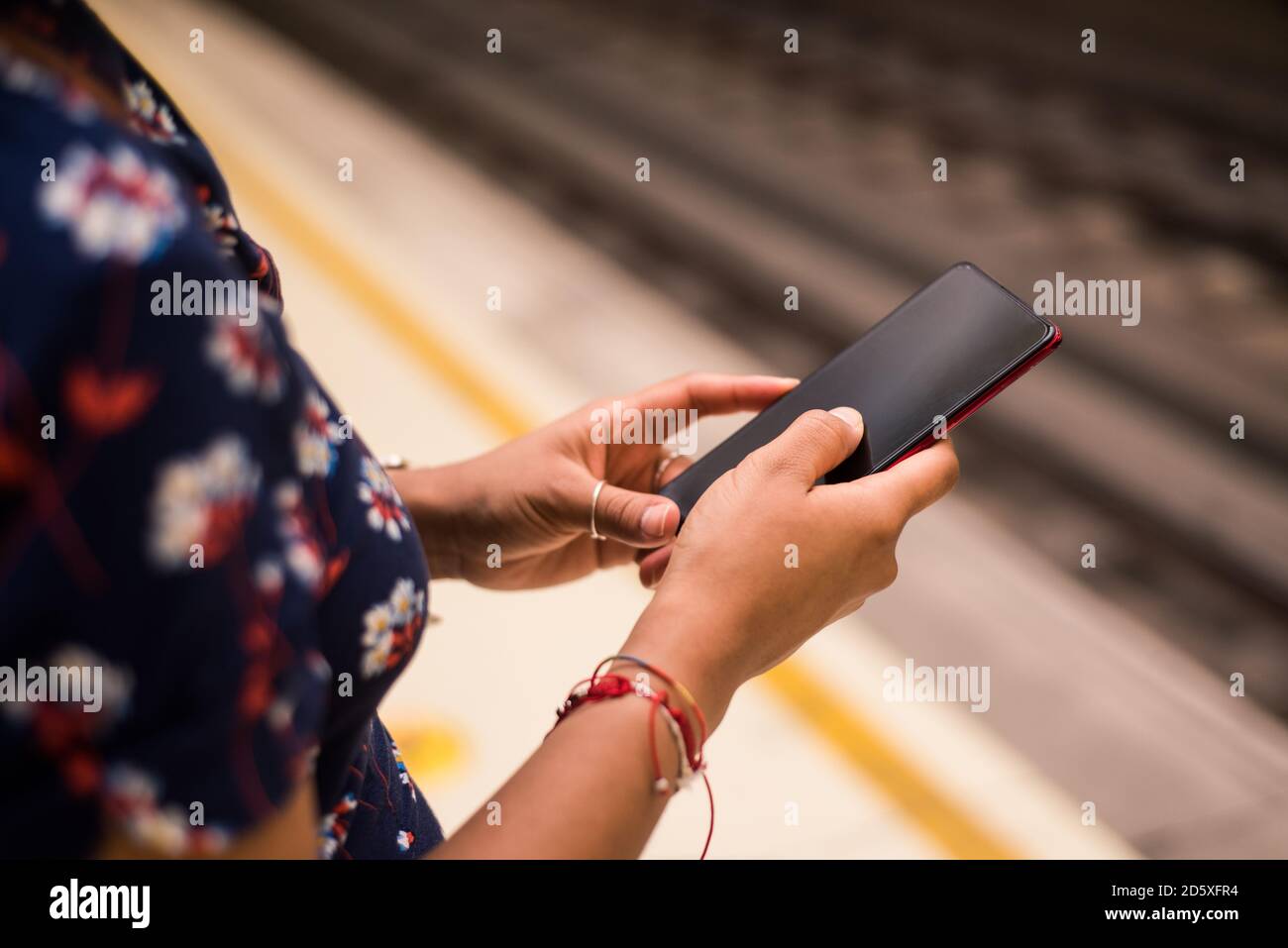 Hand using cellphone on train platform hi-res stock photography and ...