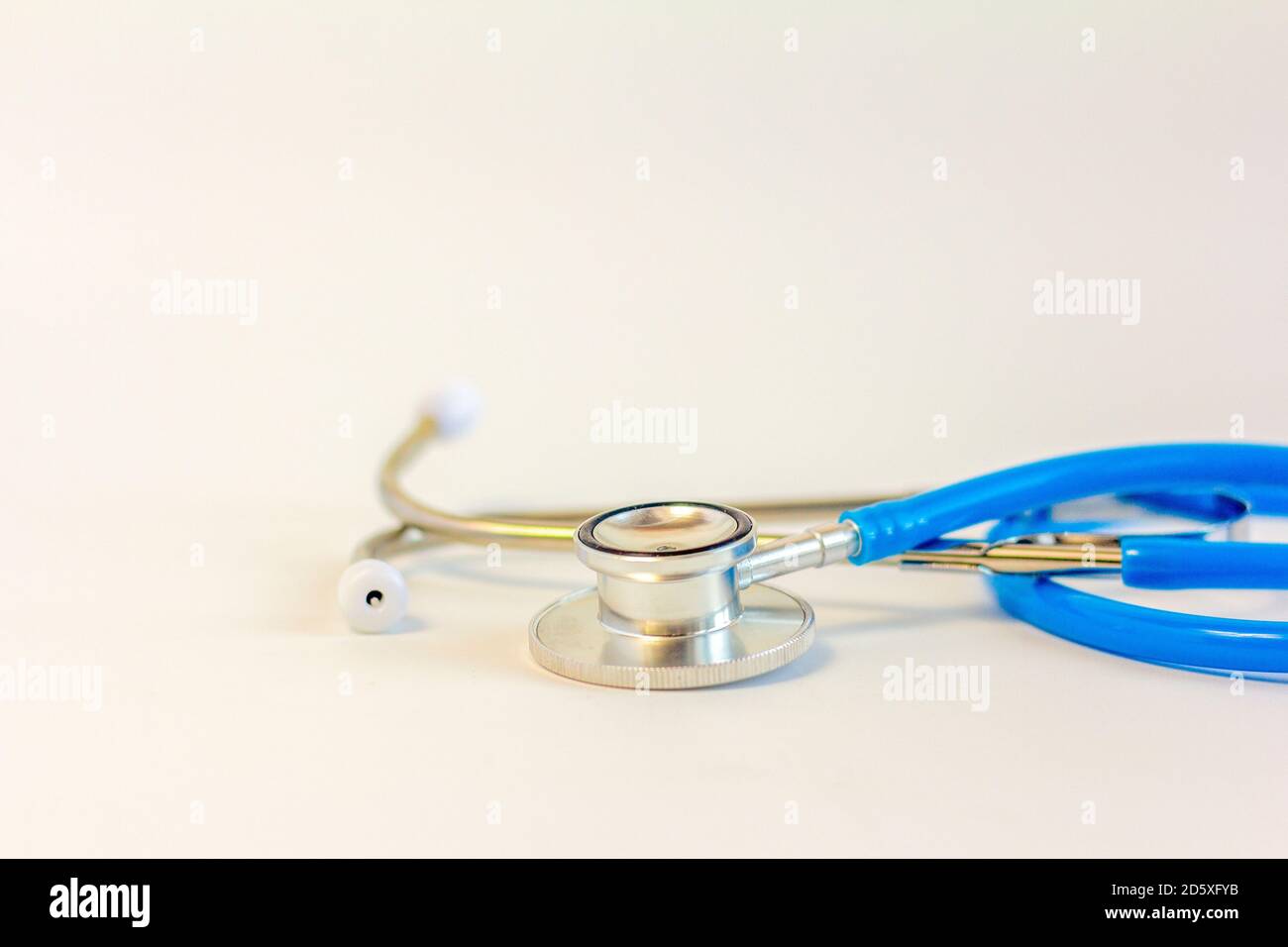Blue medical stethoscope on a white background,close-up Stock Photo - Alamy