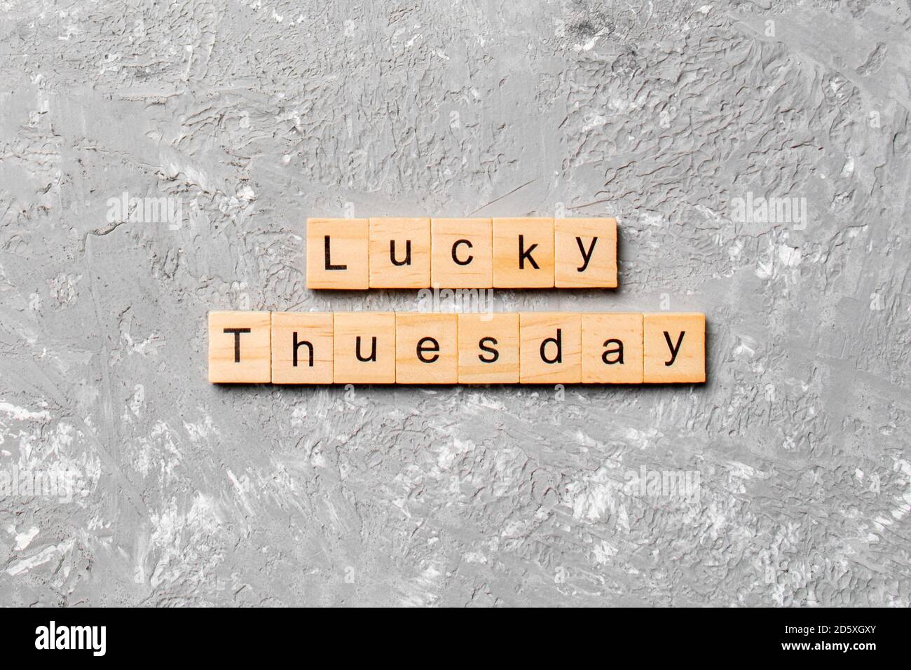 lucky Tuesday word written on wood block. lucky Tuesday text on cement ...