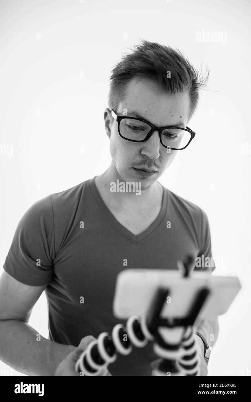 Young handsome man vlogging against hue of light Stock Photo - Alamy