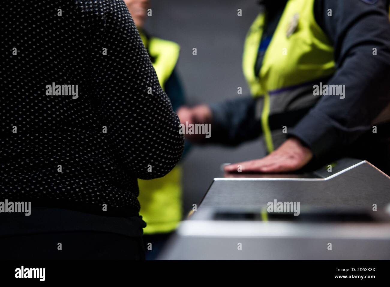 Security guard in subway station. Guard checking an automatic ticket ...