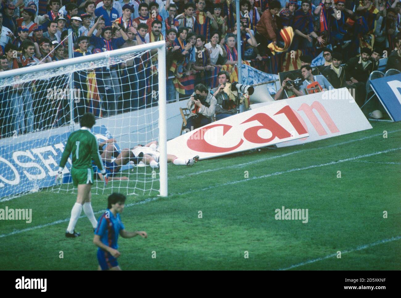 An advertising board is flattened by two players during the game Stock ...