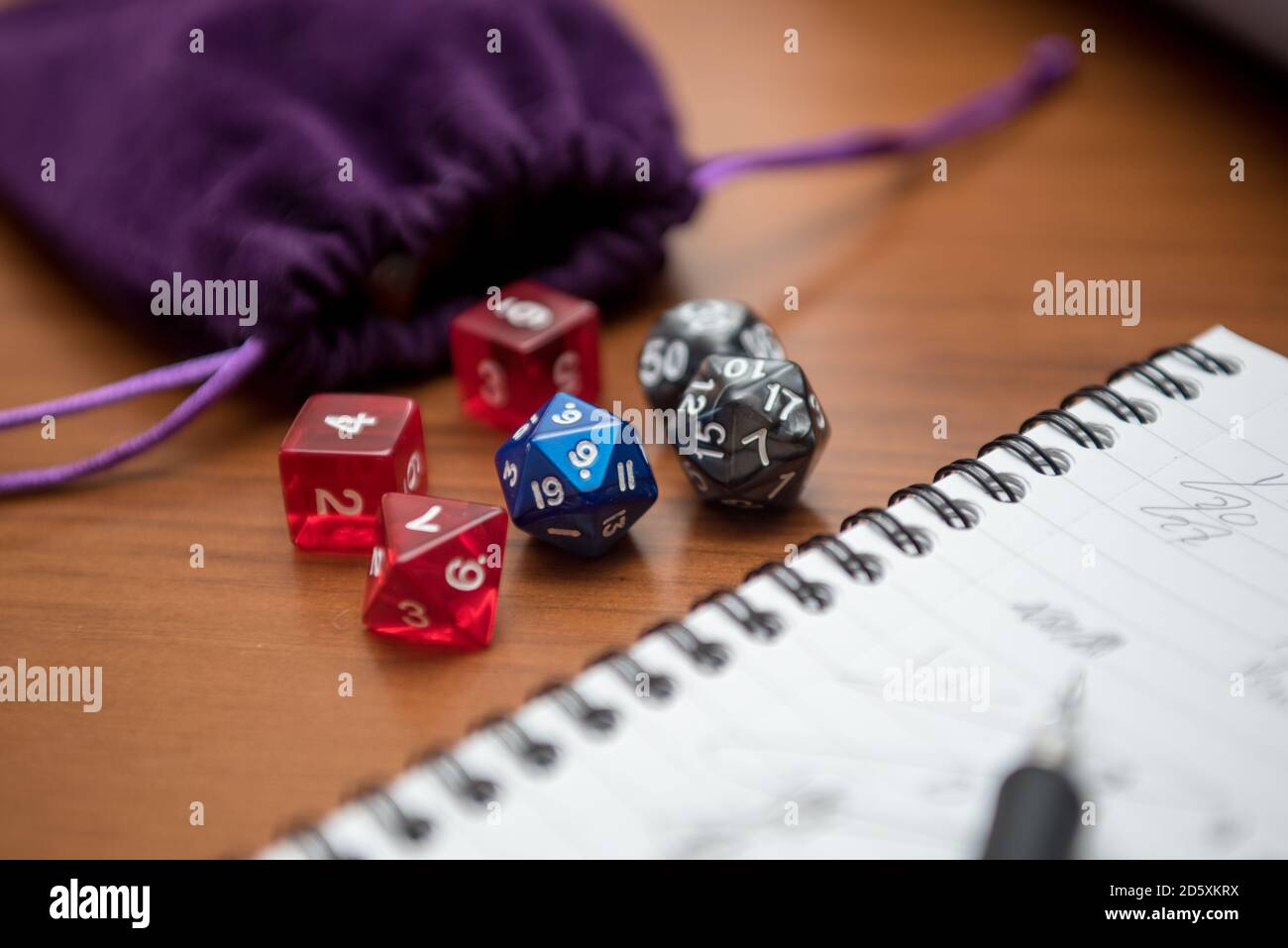 Set of pen, notebook, and dices to play role game like dungeons and ...