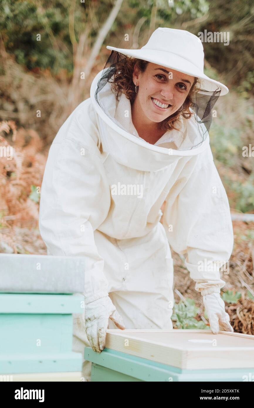 Young woman beekeeper at work in a nature Stock Photo - Alamy