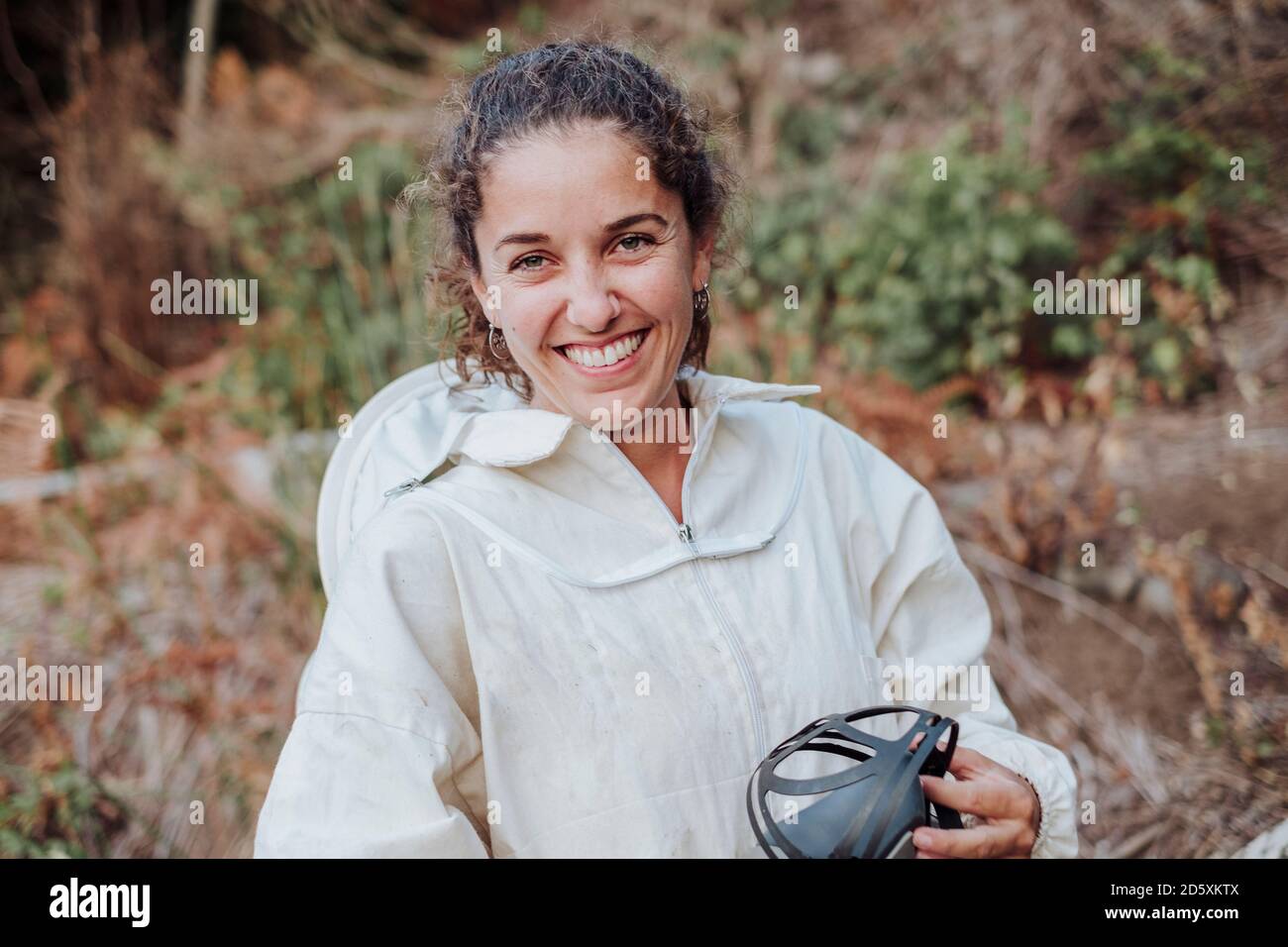 Young woman beekeeper at work in a nature Stock Photo - Alamy