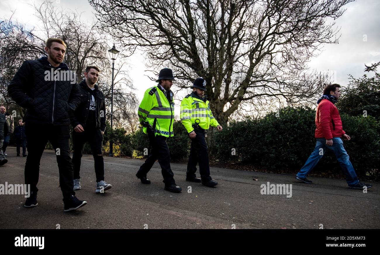 Police watch over fans outside ground hi-res stock photography and ...