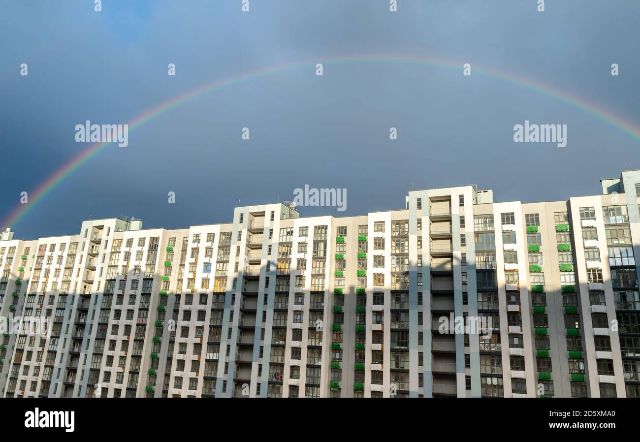 Rainbow over a high-rise building. Multi-apartment residential building ...