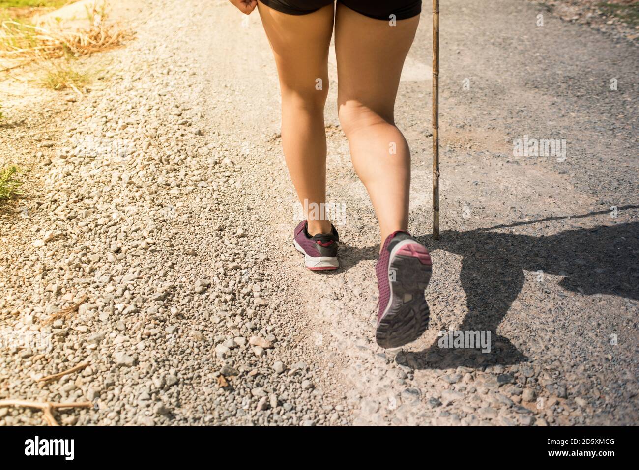 Young fitness woman hiker legs at rural trail. Concept of hiking ...