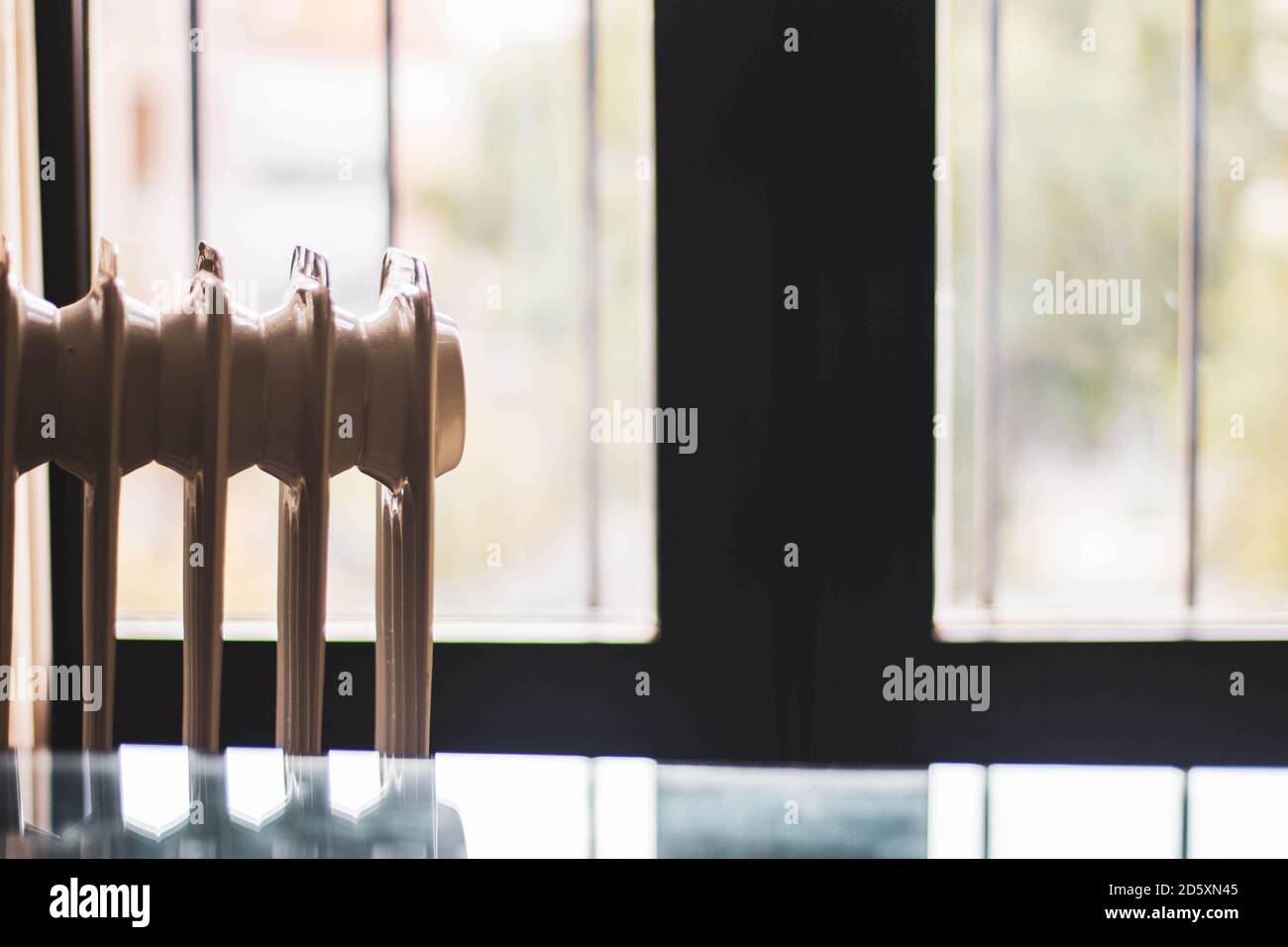 portable electric radiator against window in winter Stock Photo - Alamy