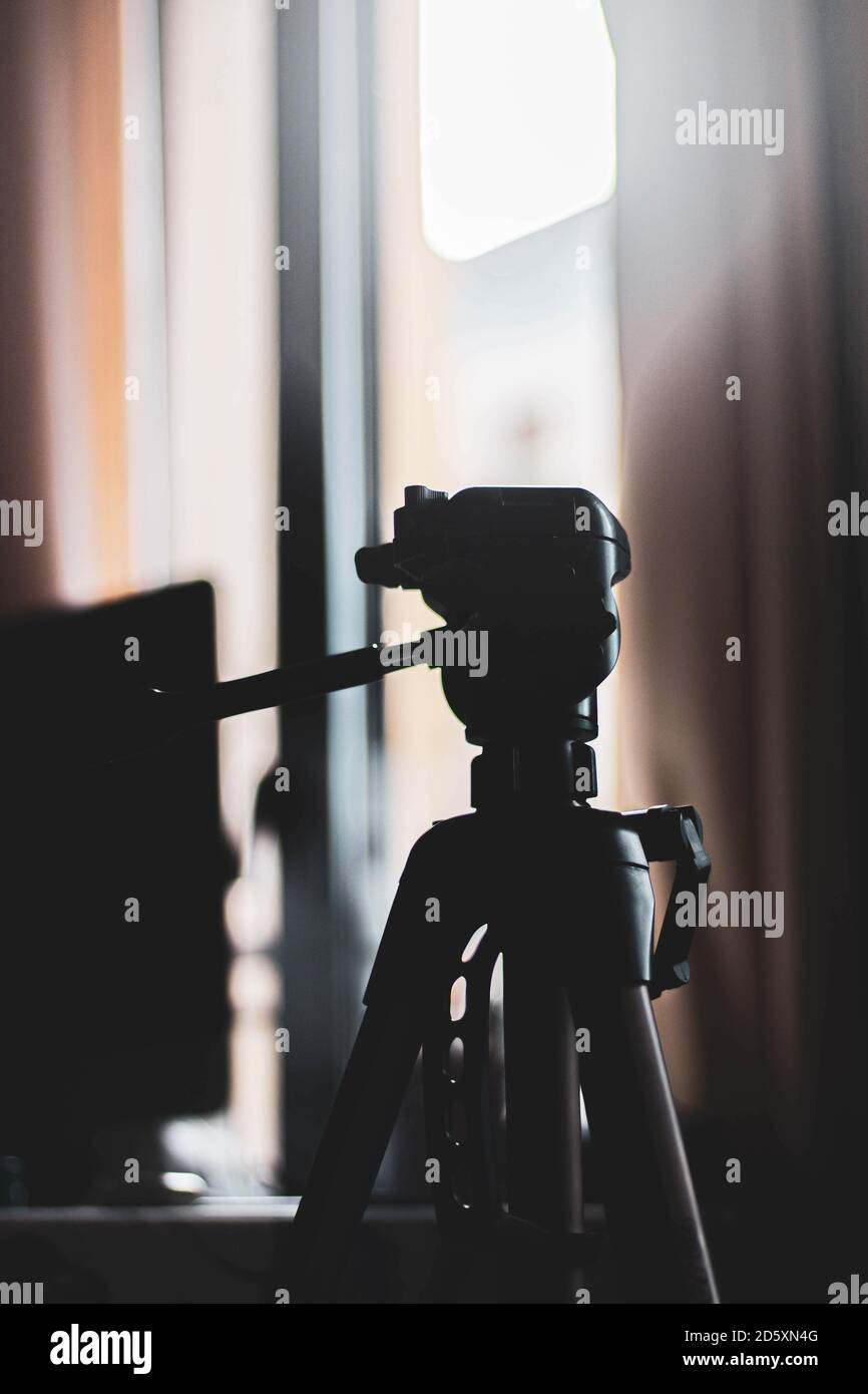 tripod in the house window Stock Photo - Alamy