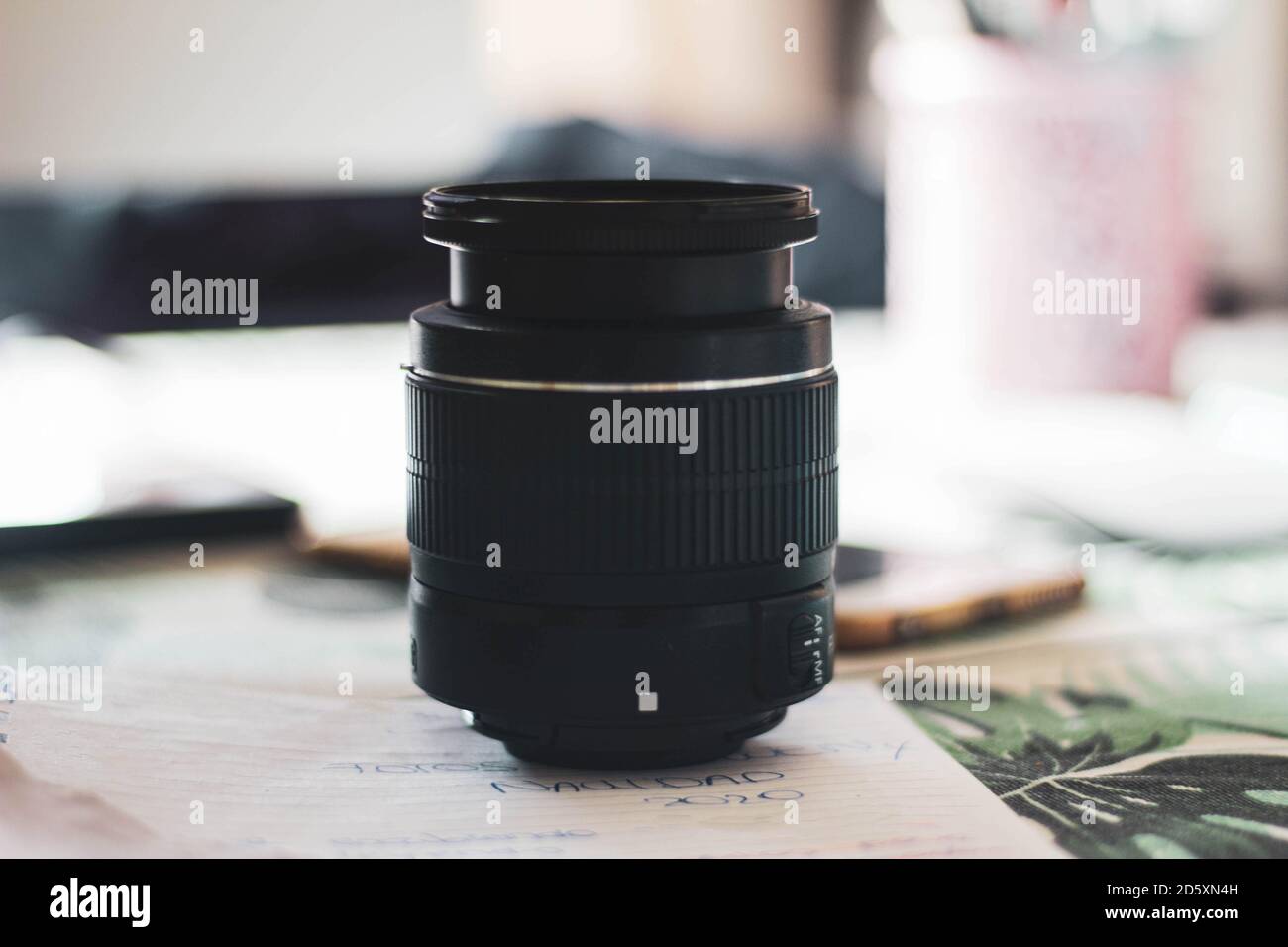 camera lens on top of notes and papers on a table Stock Photo - Alamy