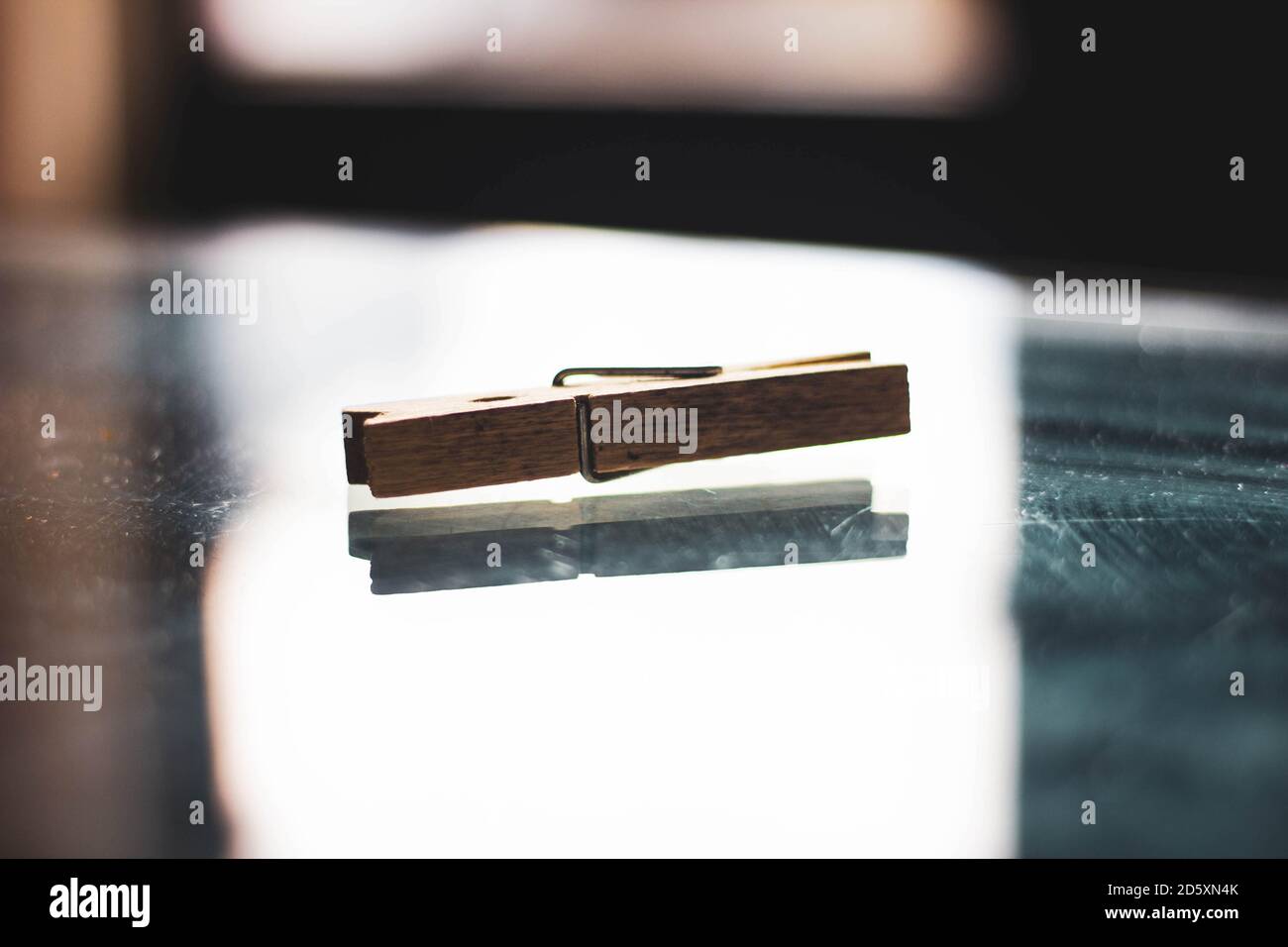 wooden clothespin on top of glass table Stock Photo - Alamy