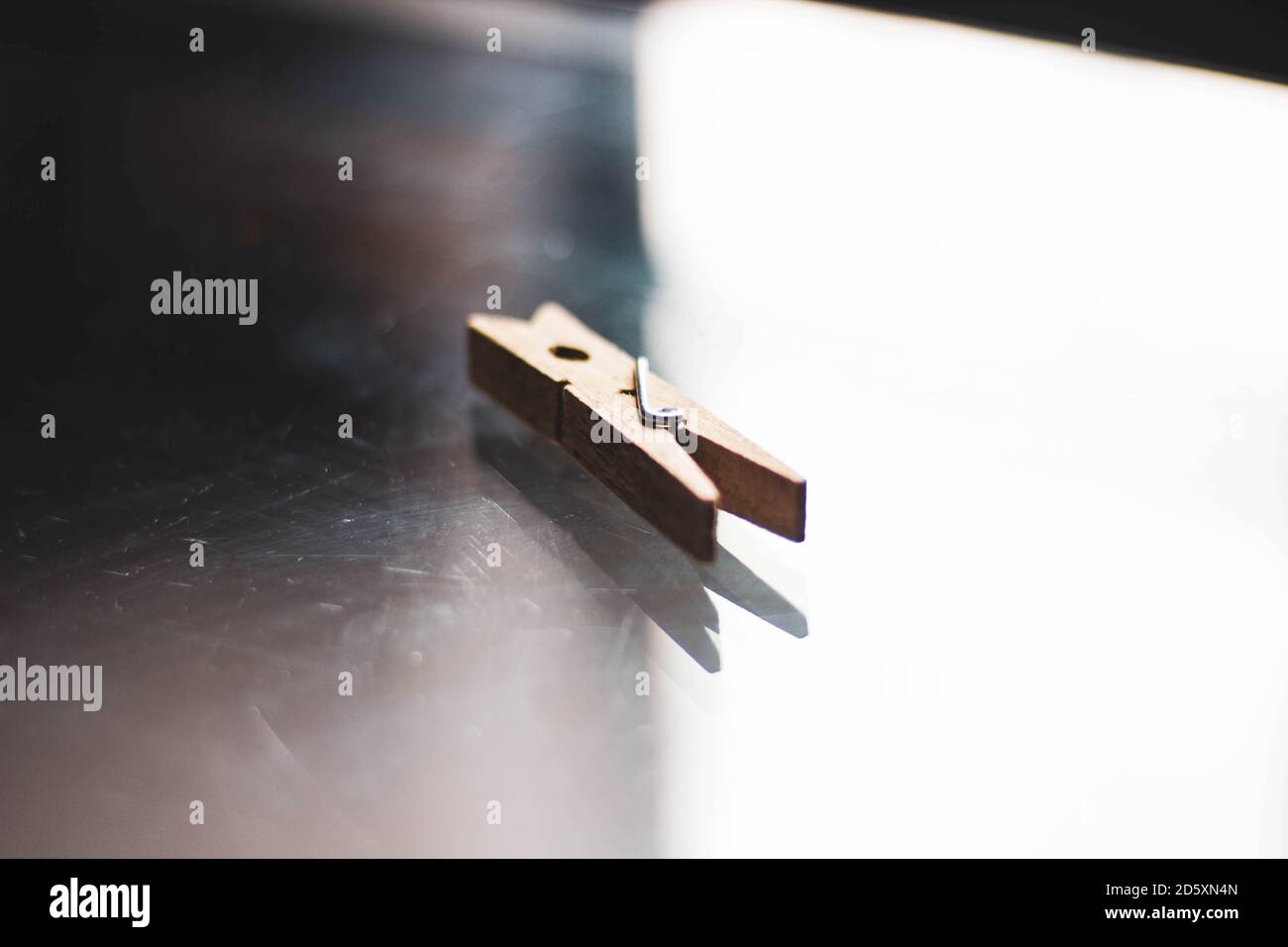 wooden clothespin on top of glass table Stock Photo - Alamy