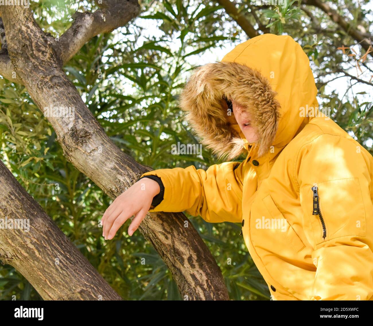 white boy wearing a yellow coat with a hood with hair at the end that ...