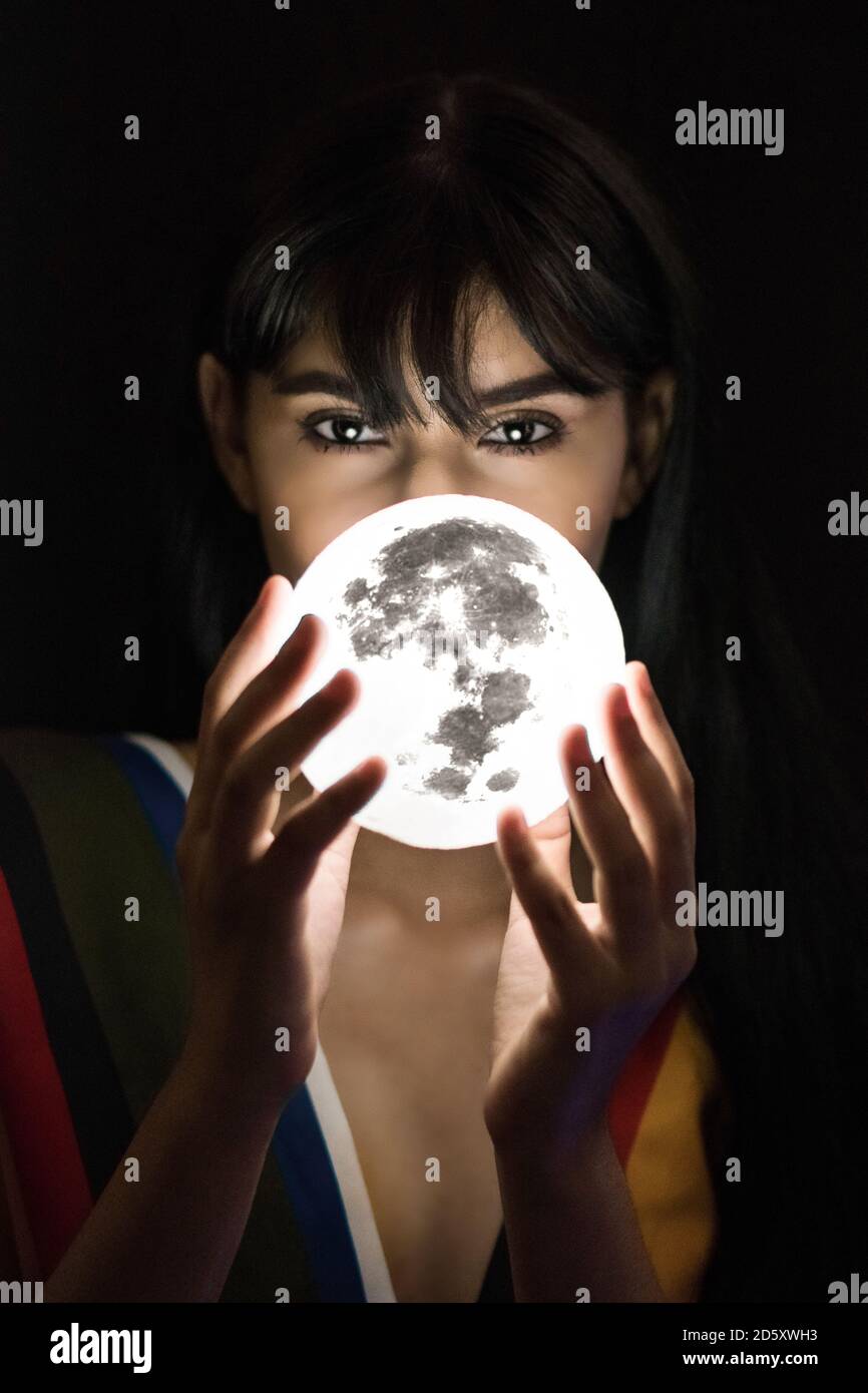 a girl with moon globe Stock Photo - Alamy