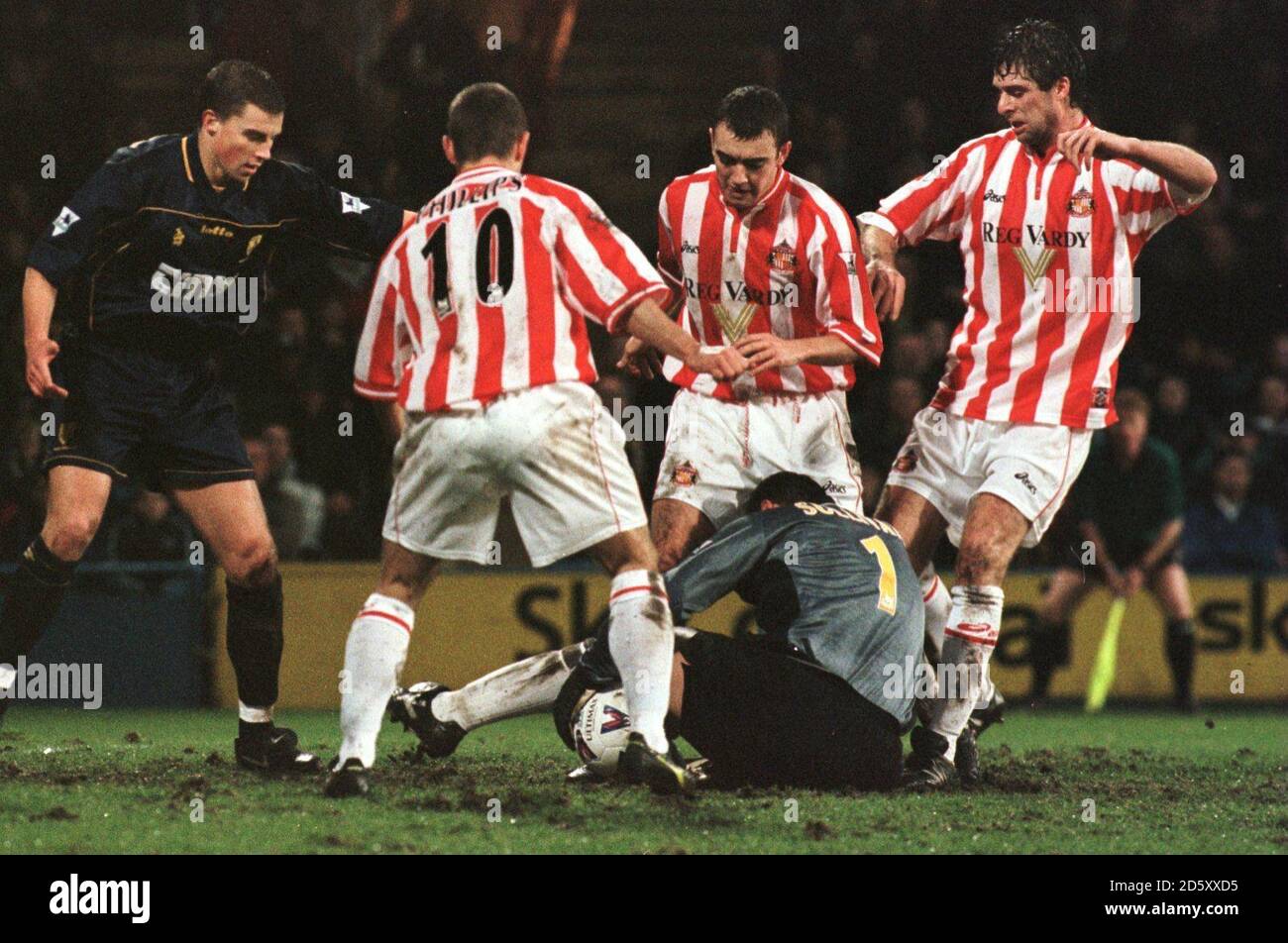 Wimbledon's Neil Sullivan is surrounded by Sunderland's Kevin Phillips ...