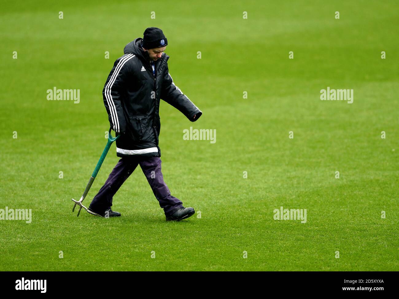 Head stadium groundsman Rob Lane walks across the pitch before the West ...