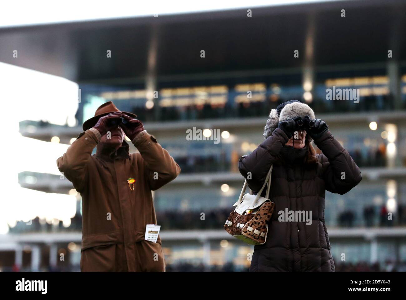 Racegoers look on through binoculars in front of the Princess Royal ...