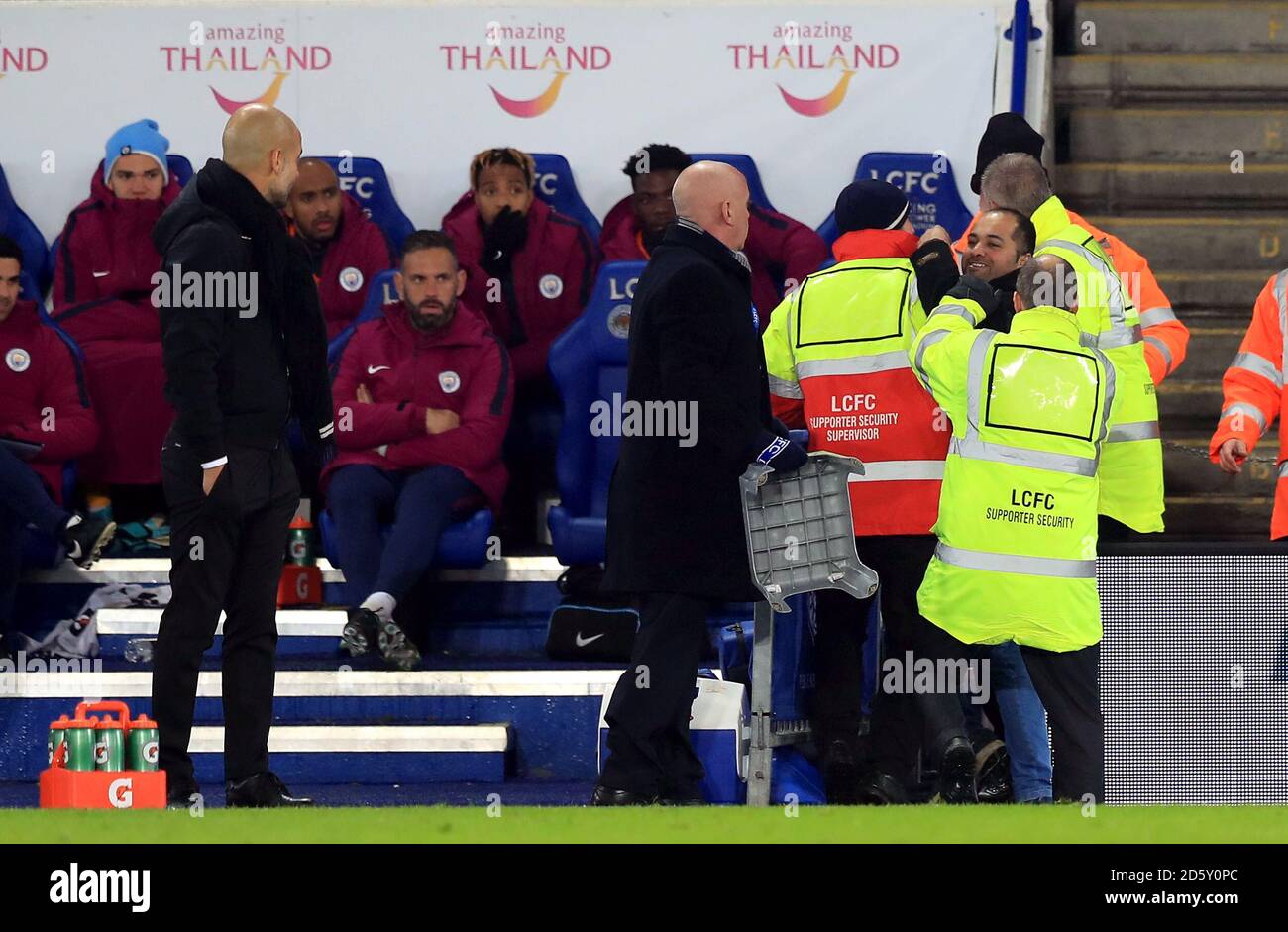 A fan pitch side approaches Manchester City manager Pep Guardiola Stock ...