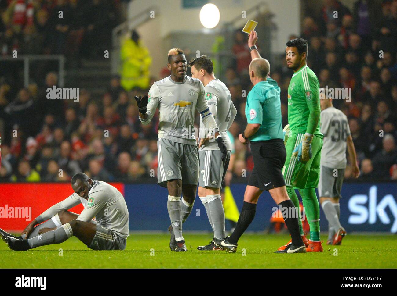 Manchester United's Paul Pogba is shown the yellow card by referee Mike ...