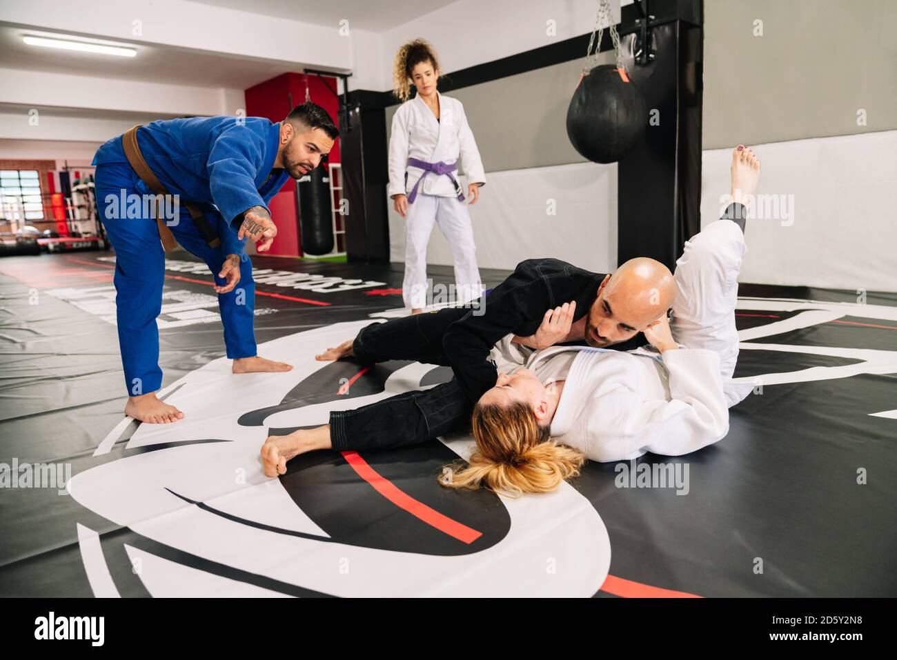 group of four judo martial arts partners and an instructor practicing ...