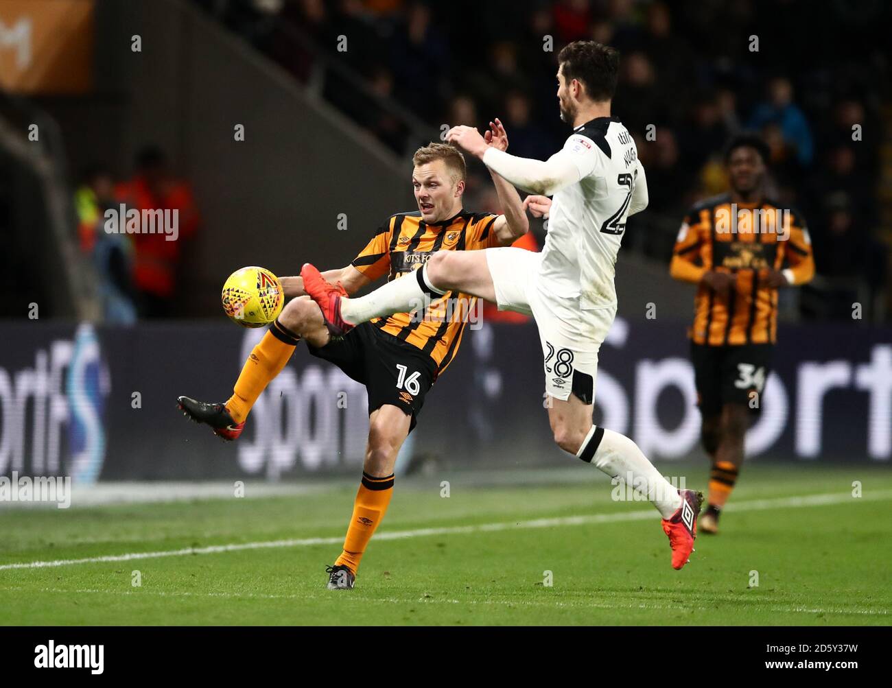 Hull City's Sebastian Larsson clears the ball under pressure from Derby ...