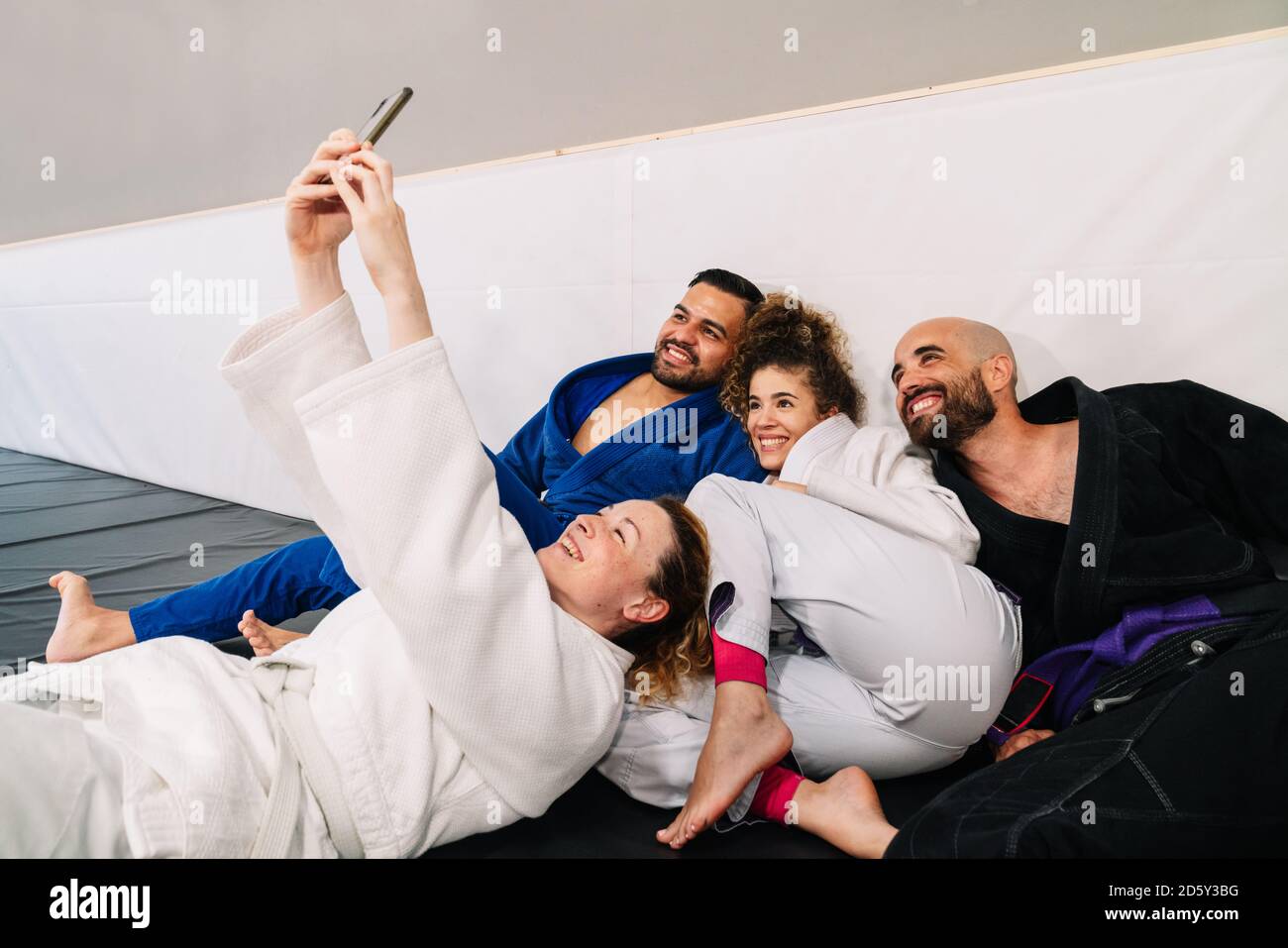 Portrait of four companions of martial arts like judo using kimono ...