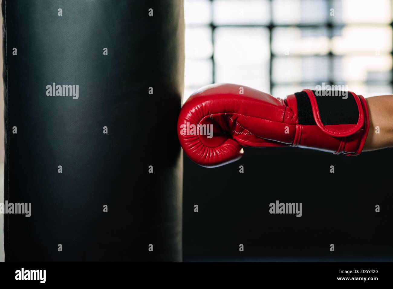 concept of a side view of a red punching glove hand hitting a straight ...