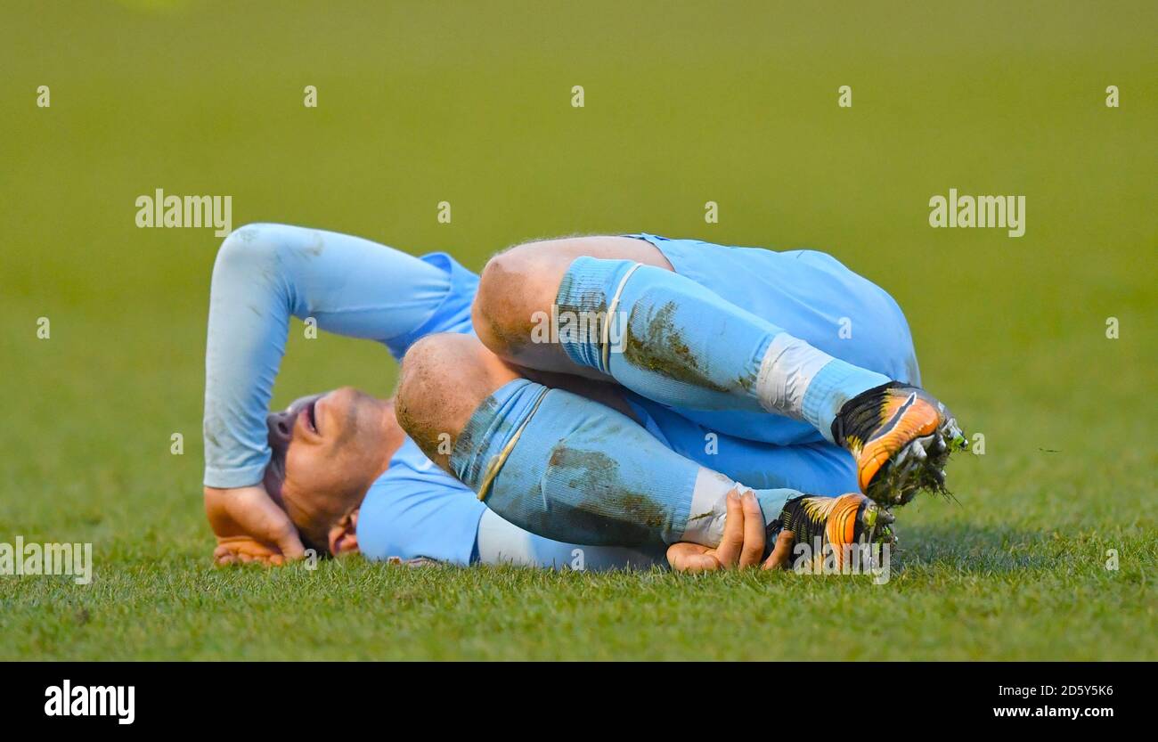 Coventry City's Stuart Beavon holds his ankle as he lies injured on the ...