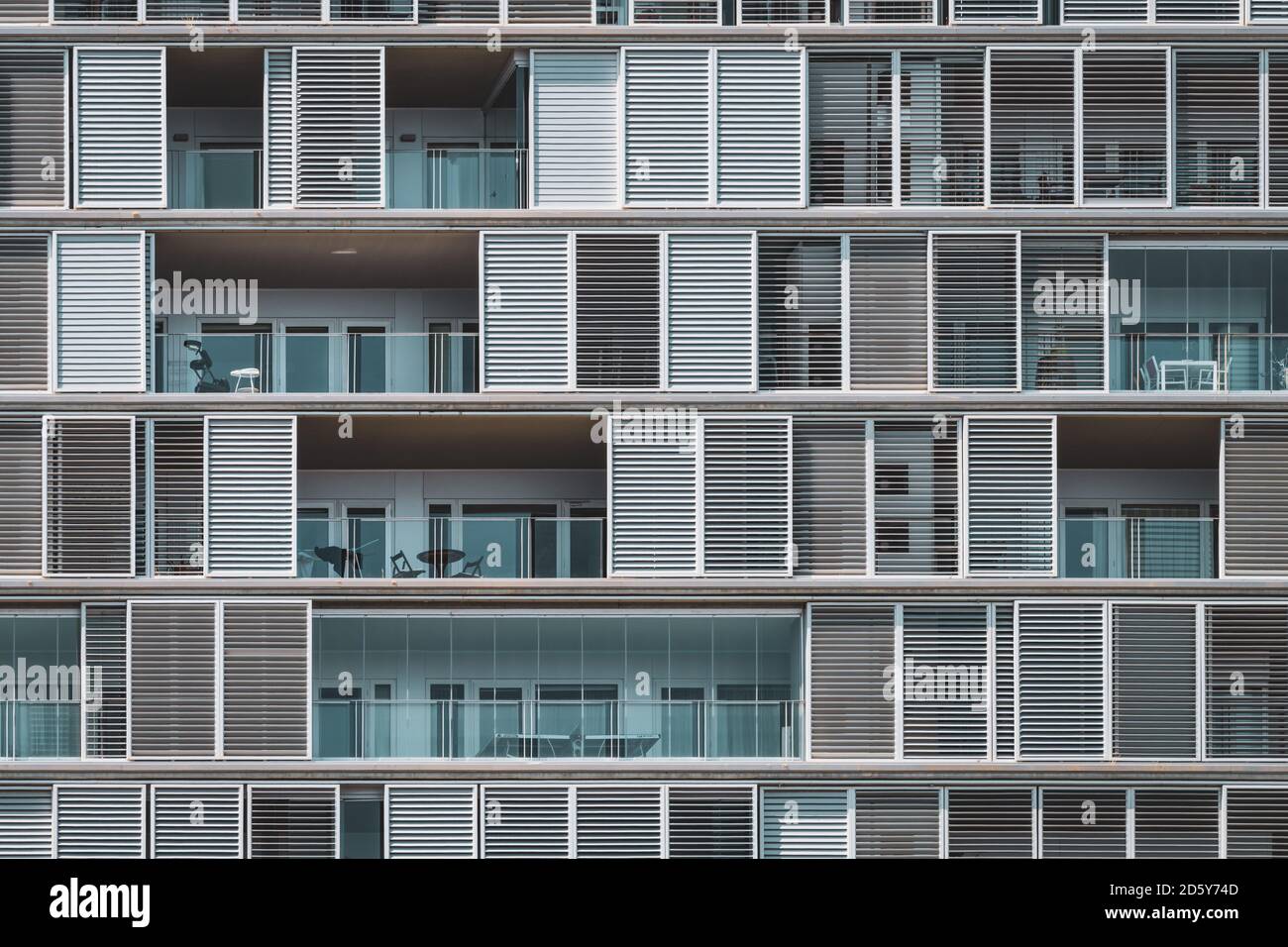 Frontal geometrical view of the shutters and balconies of an urban ...
