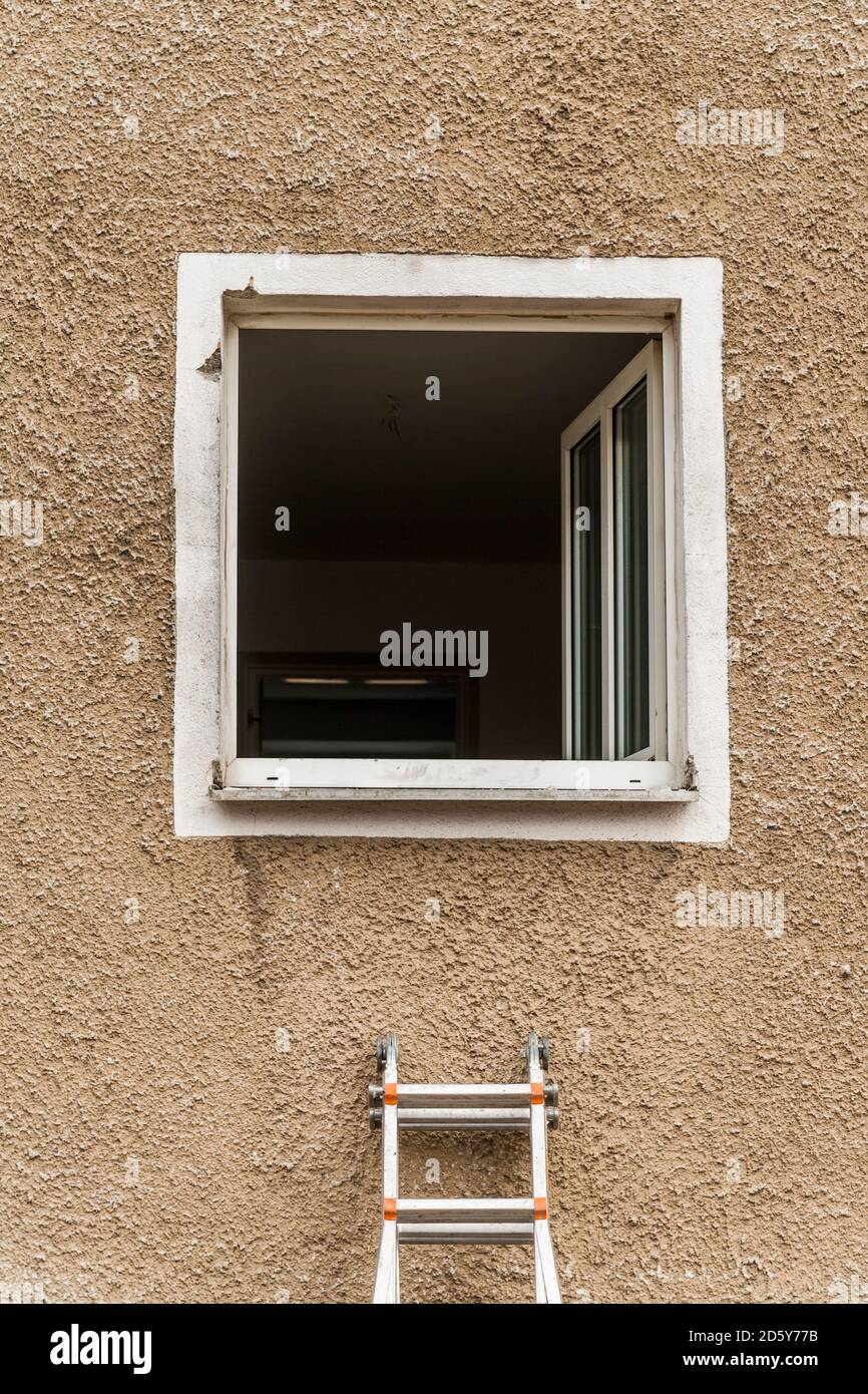 Germany, Munich, ladder leaning at house front with open window Stock ...