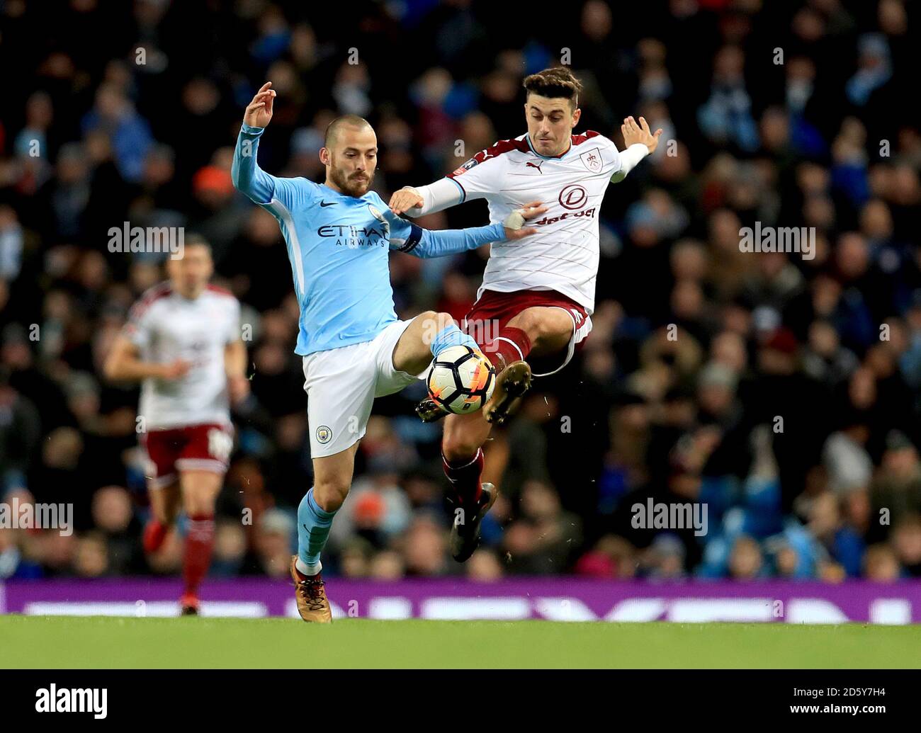 Manchester City's David Silva (left) and Burnley's Matthew Lowton ...